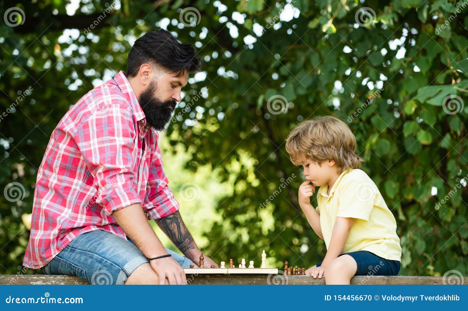 Father and Son Playing Chess. Chess. Father Teaching His Son To Play ...