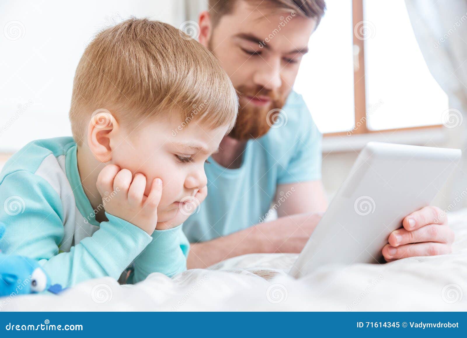 Father and Son Playing Computer Games on Tablet at Home Stock Image ...