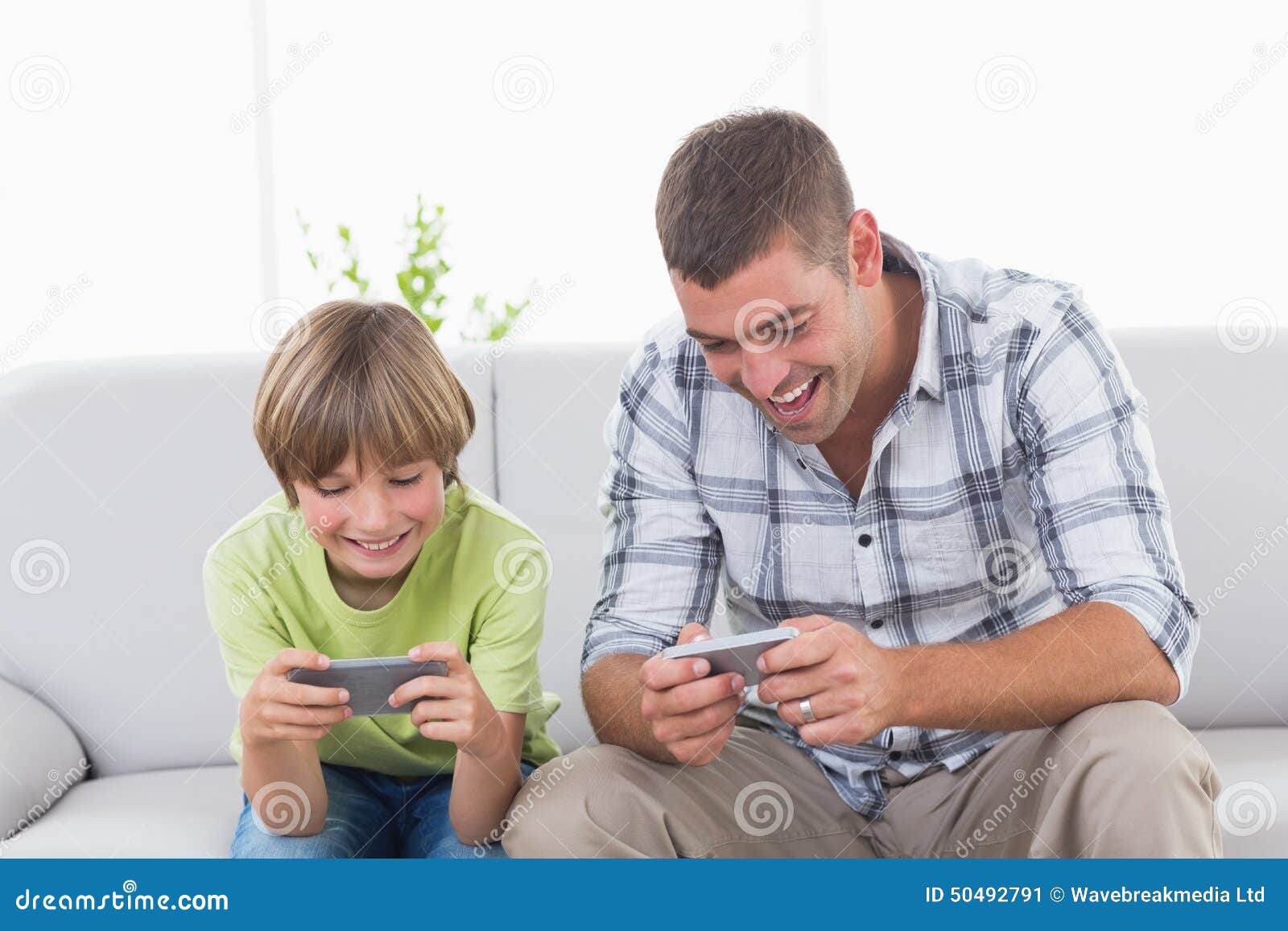 Father and Son Playing Games on Mobile Phone Stock Image - Image of ...