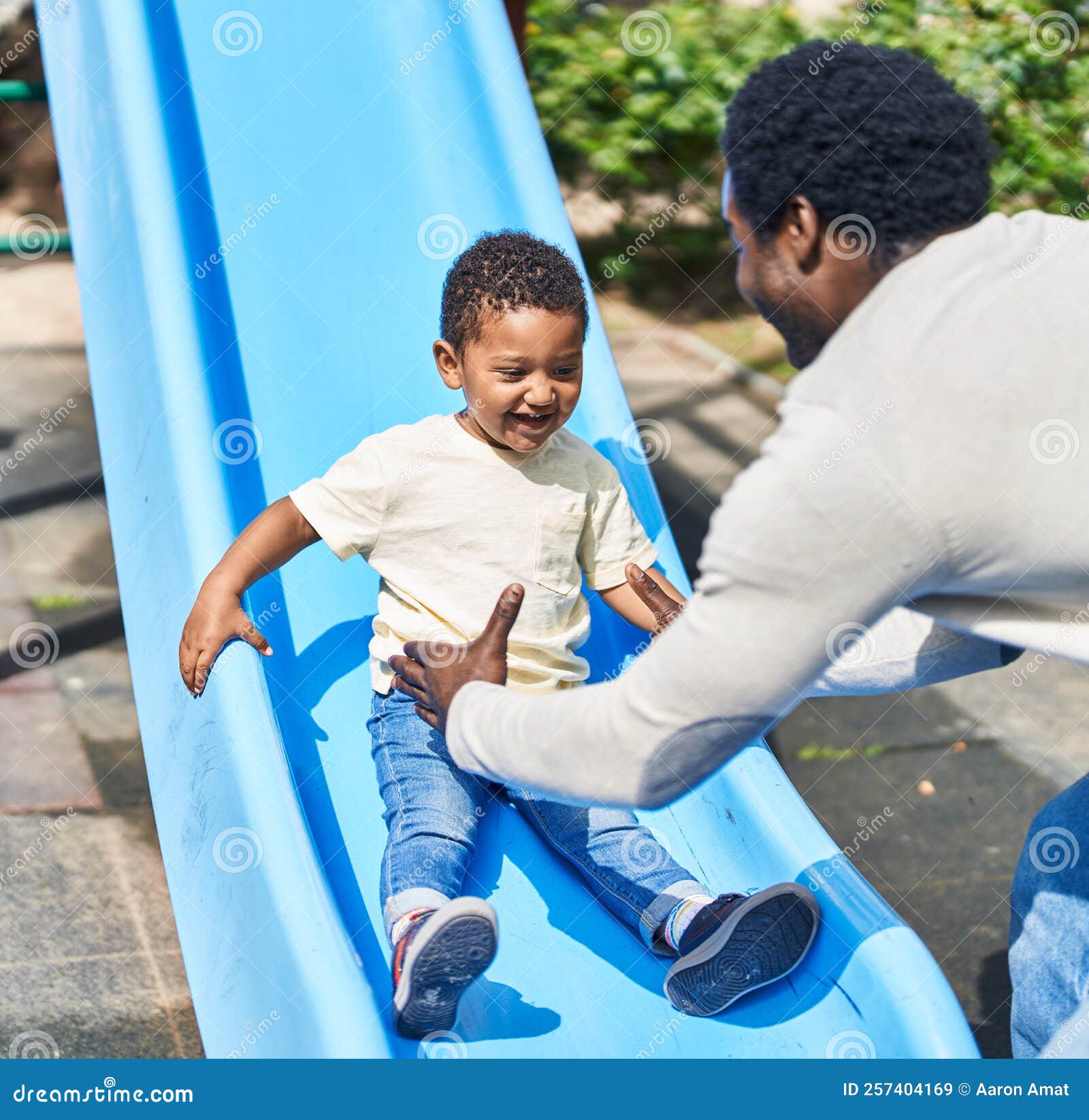 Father and Son Playing on Slide at Playground Stock Image - Image of ...
