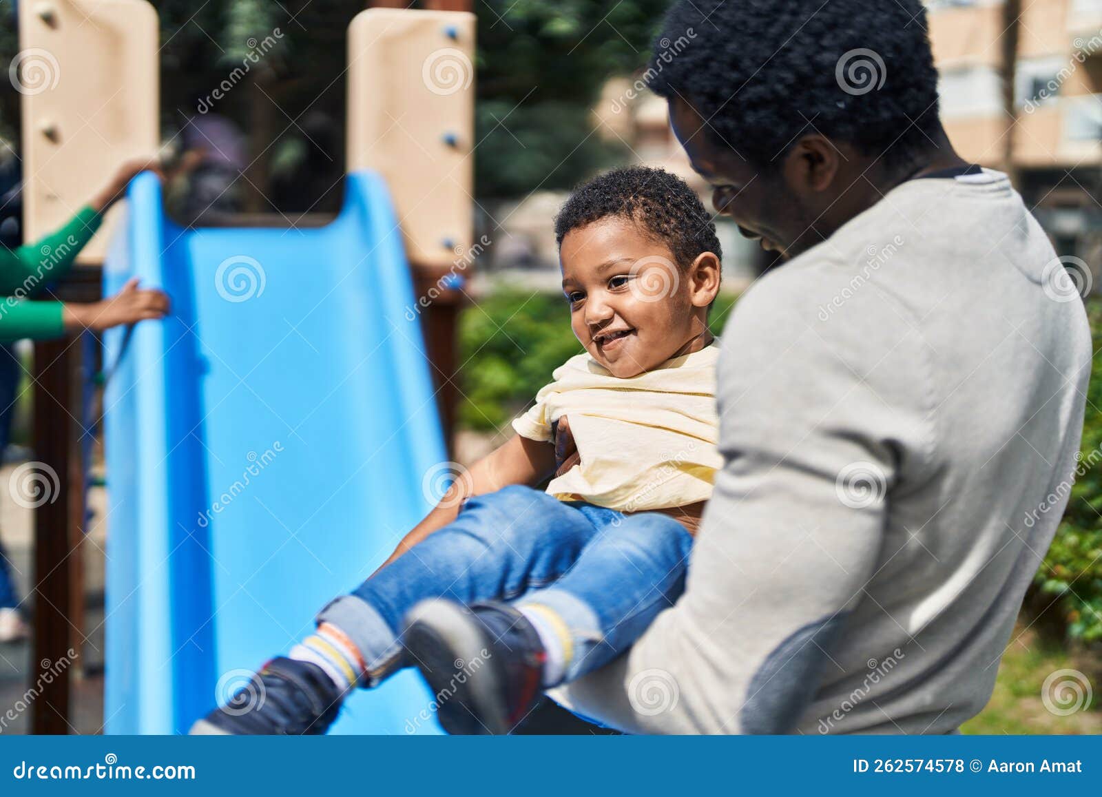 Father and Son Playing on Slide at Playground Stock Photo - Image of ...