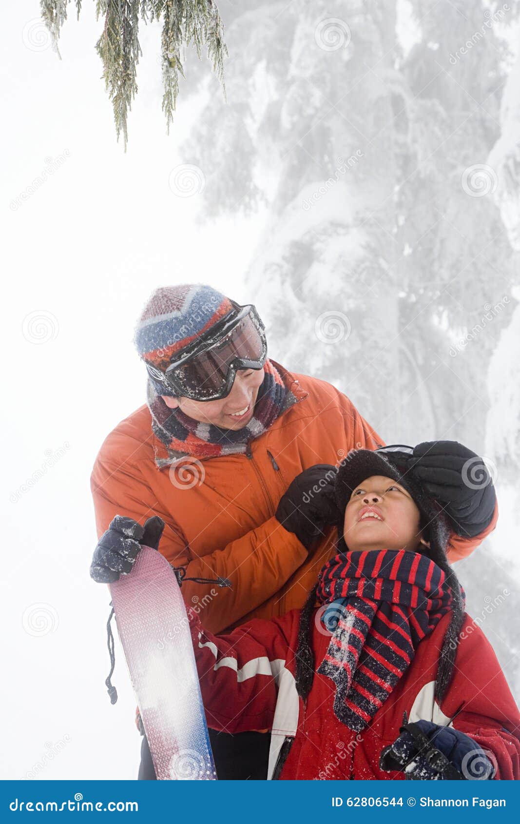 Father and Son Preparing for Skiing Stock Photo - Image of father ...