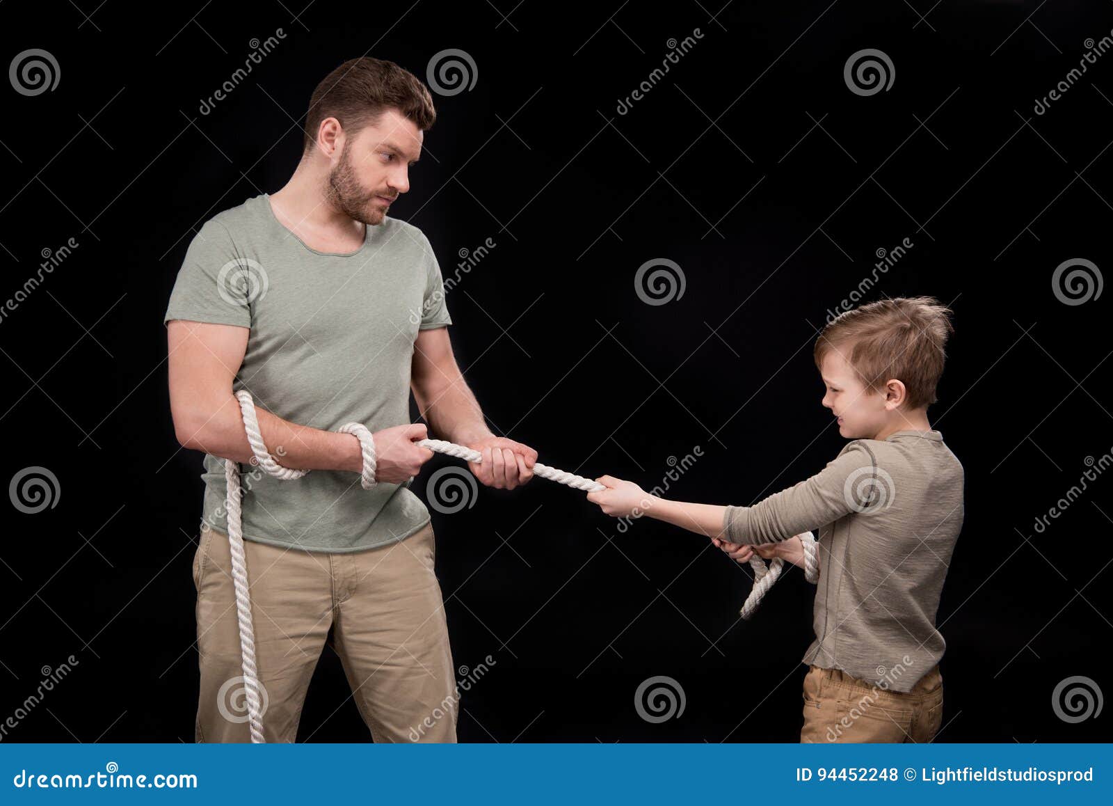 Father and Son Pulling Rope Isolated on Black Stock Photo - Image of ...