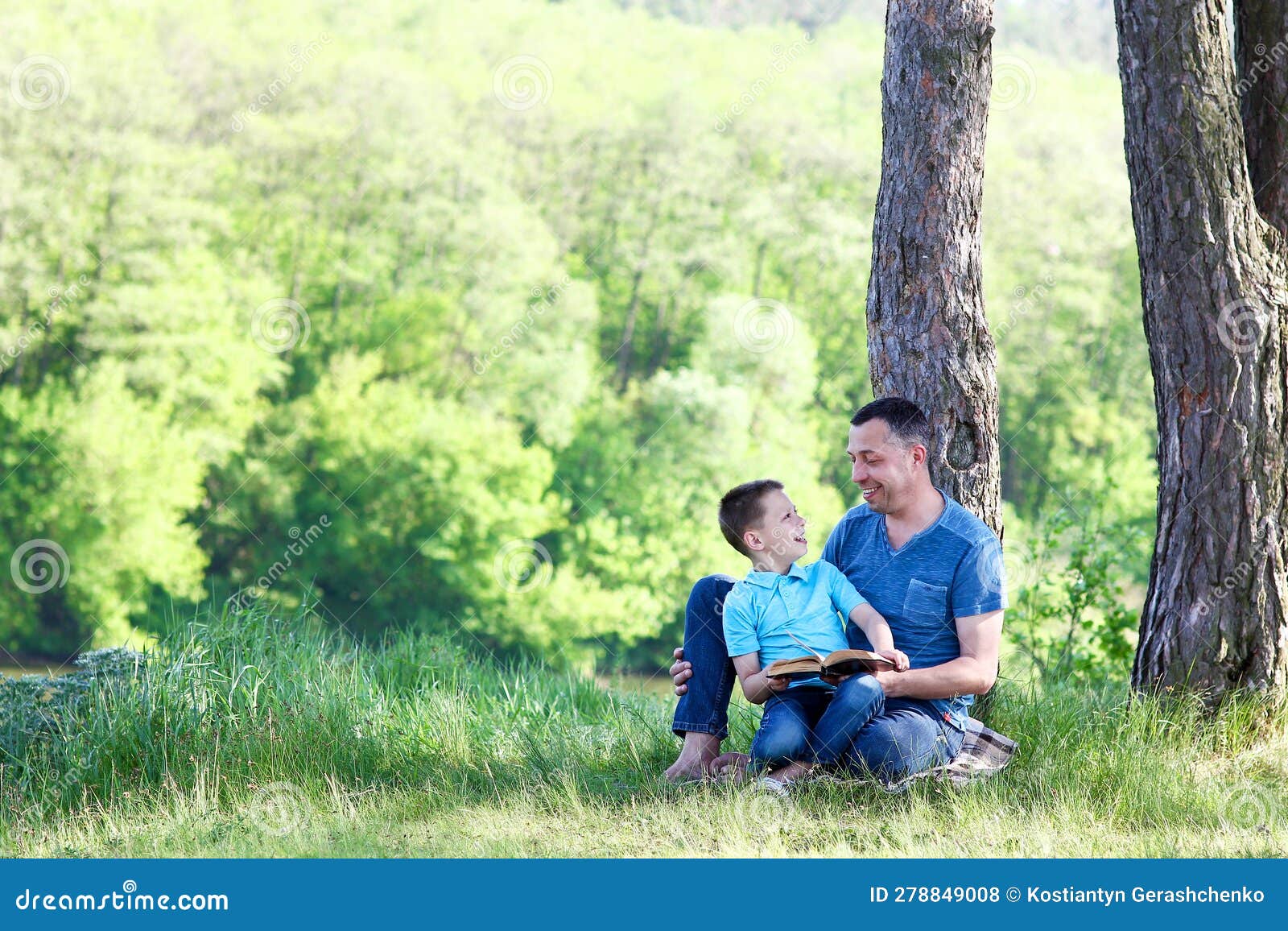 Father and Son Reading Bible Book Stock Photo - Image of small, park ...