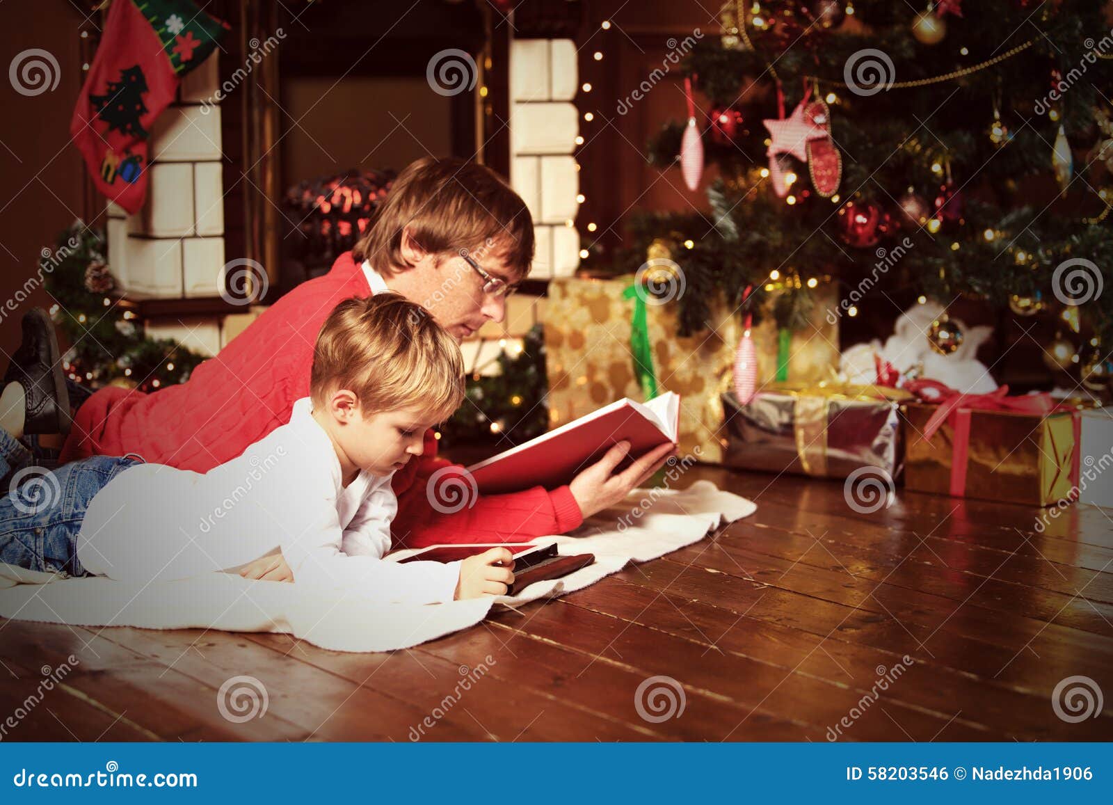Father and Son Reading Book by Fireplace Stock Photo - Image of people ...