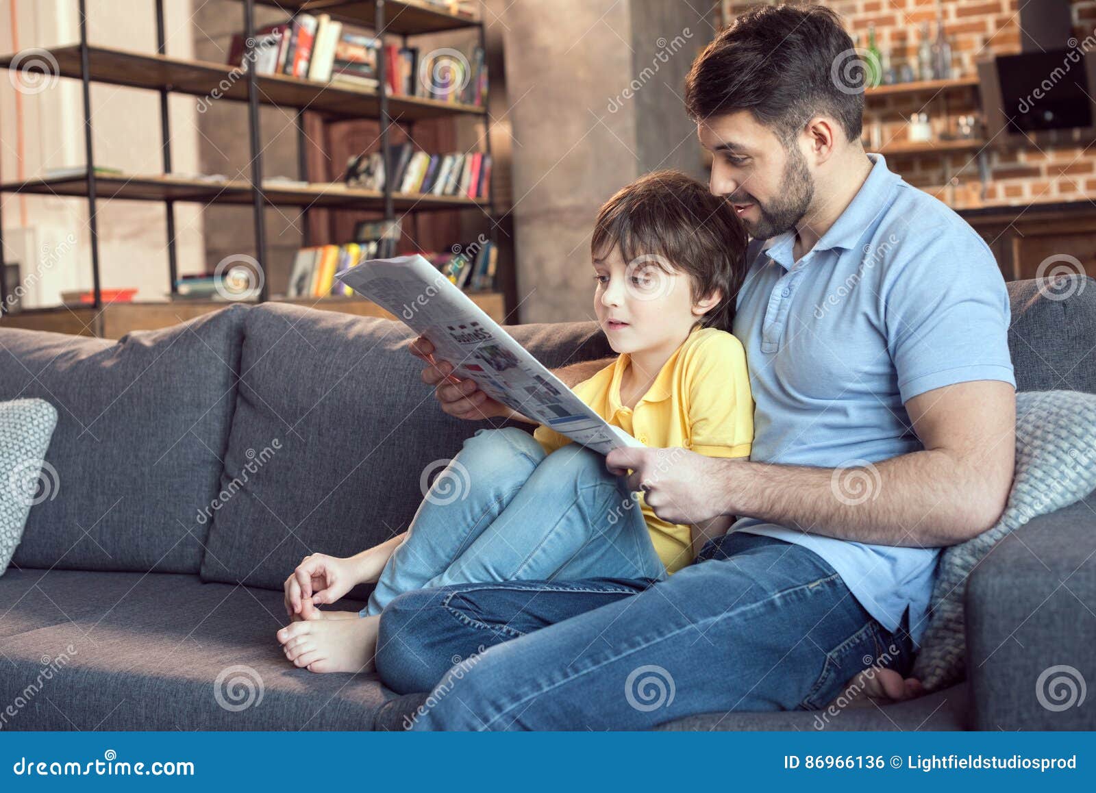 Father and Son Reading Newspaper Together Stock Photo - Image of ...