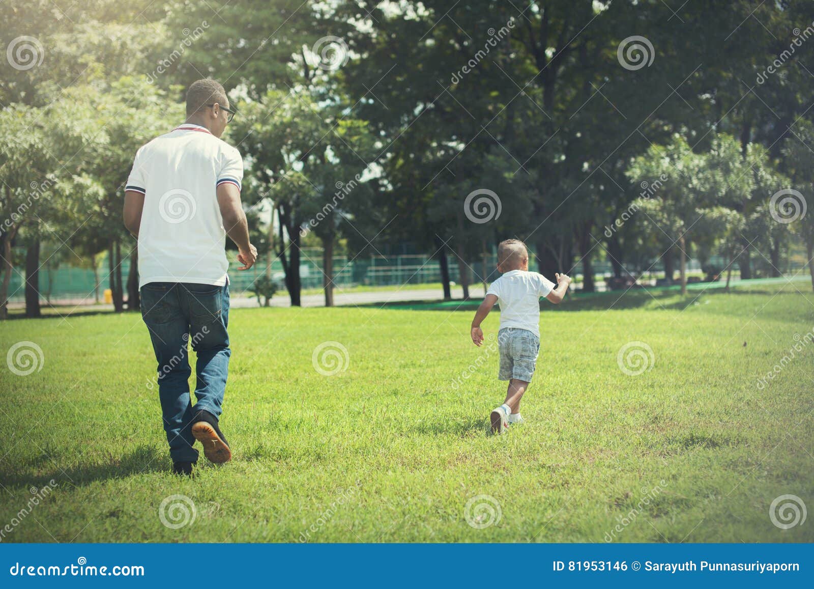 Father and Son Running and Chasing Each Other in Green Park Stock Photo ...
