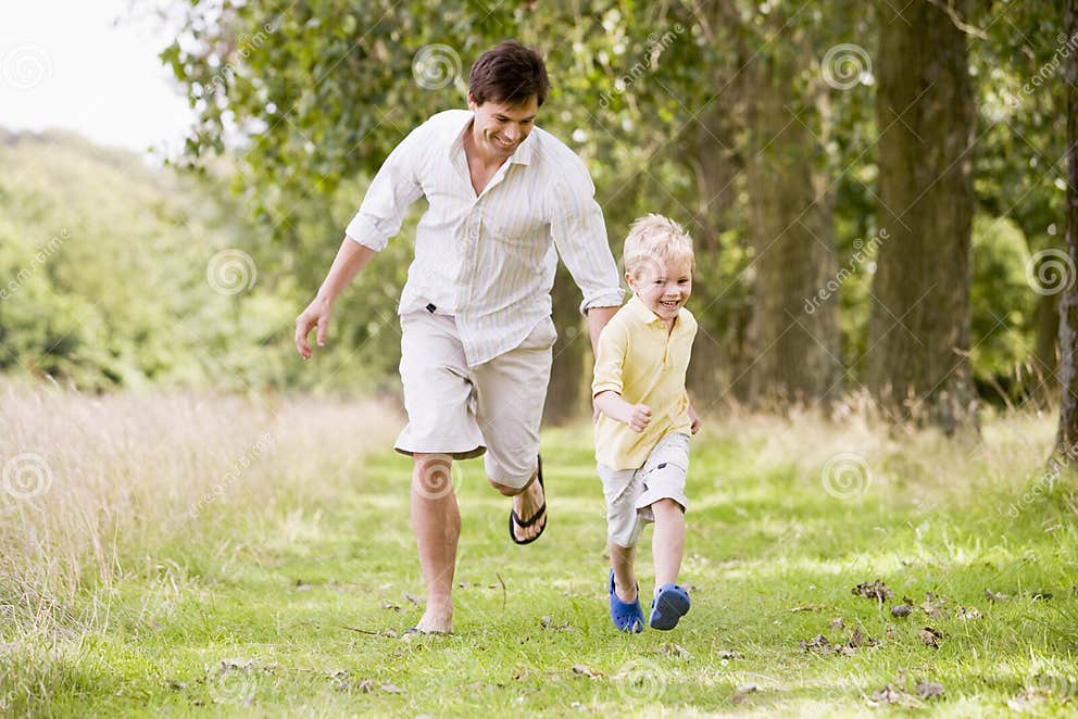 Father and Son Running on Path Smiling Stock Photo - Image of laughing ...