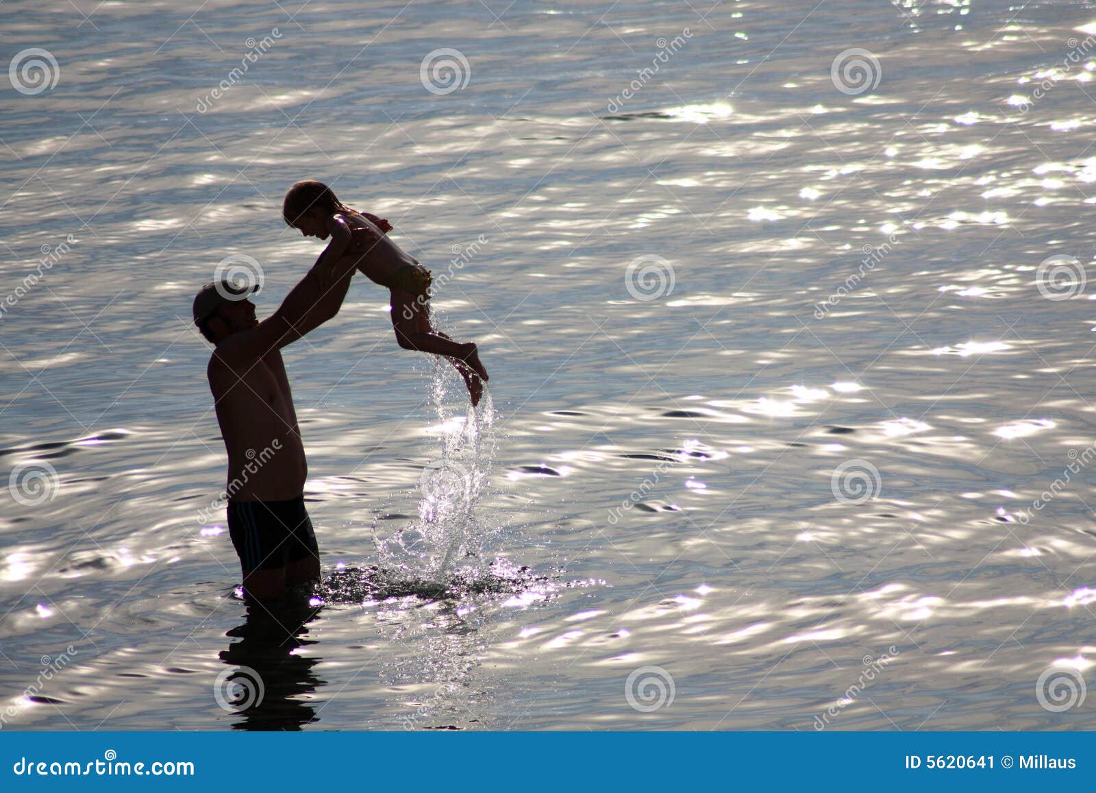 Father and son in the sea stock image. Image of contrast - 5620641