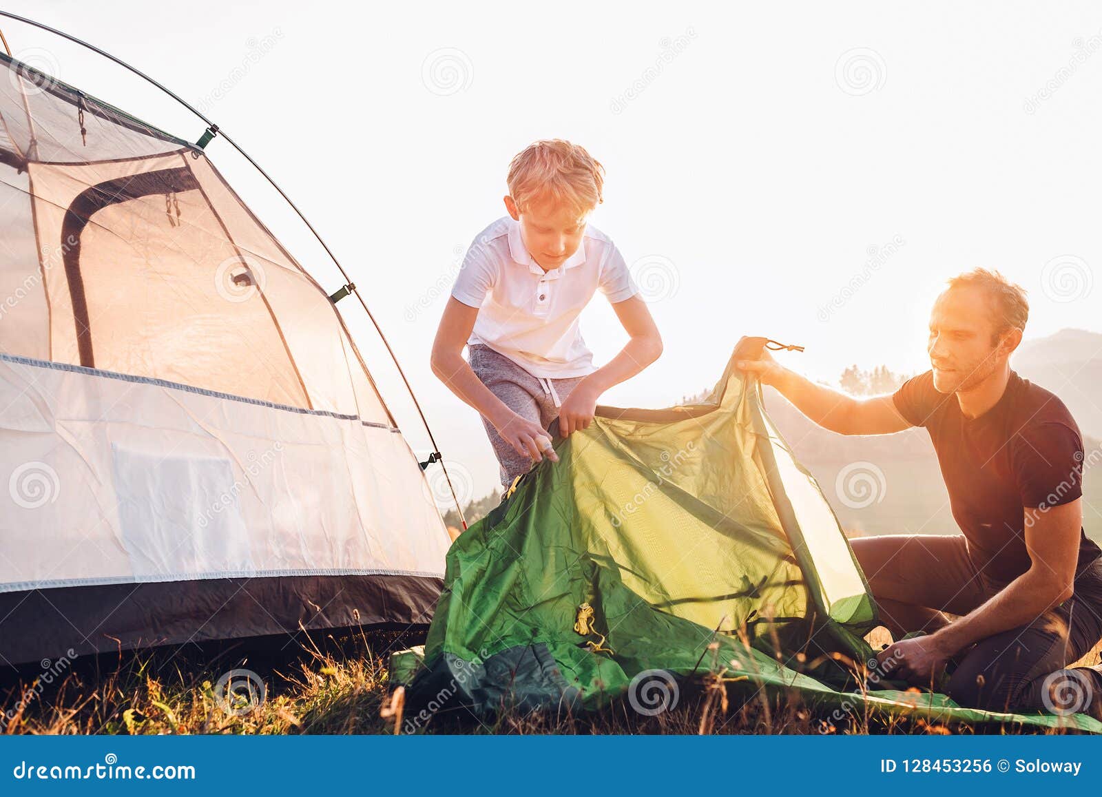Father and Son Setting Tent on Sunset Forest Glade Stock Photo - Image ...