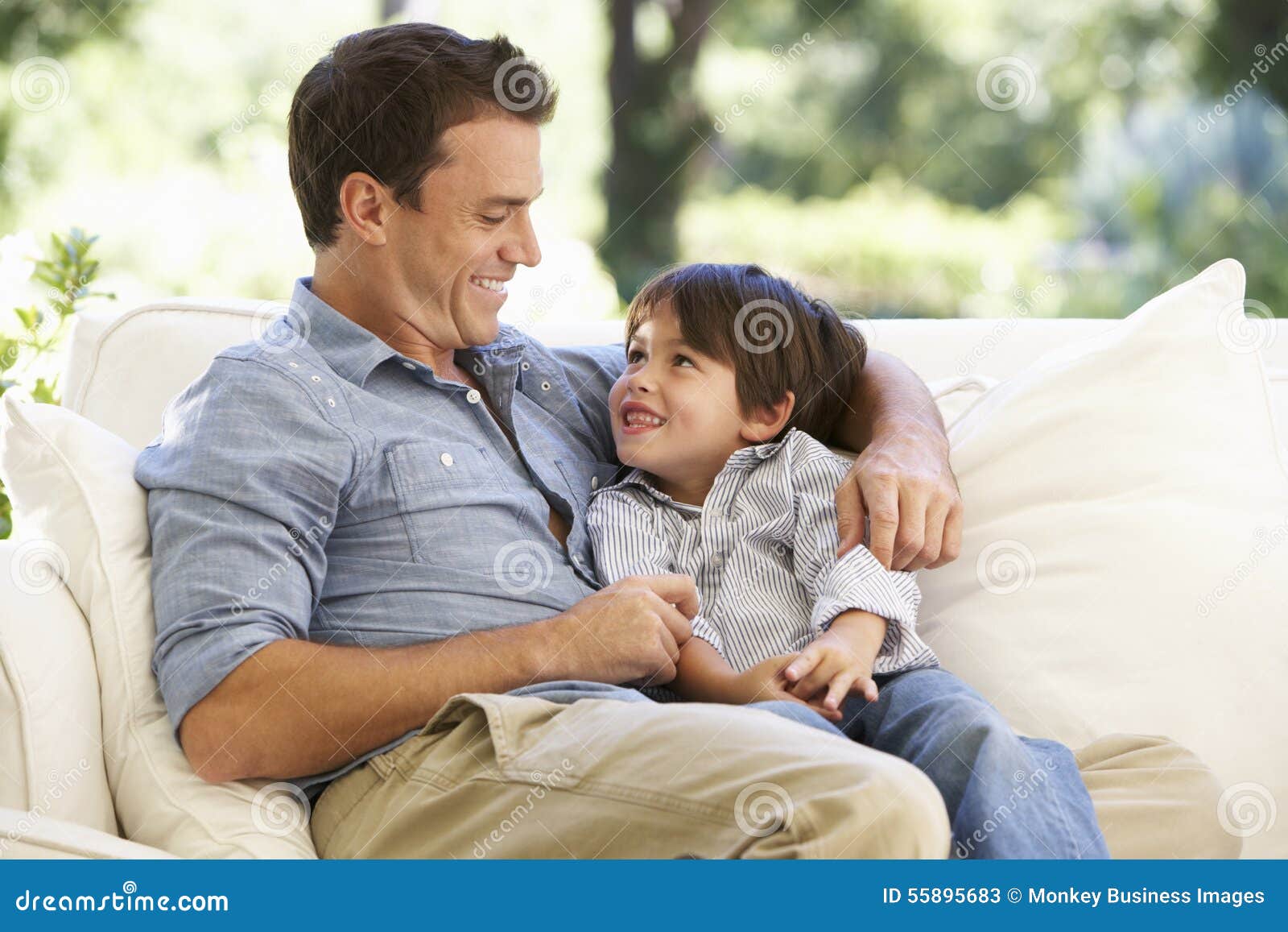 Father And Son Sitting On Sofa At Home Stock Image Image Of Smiling