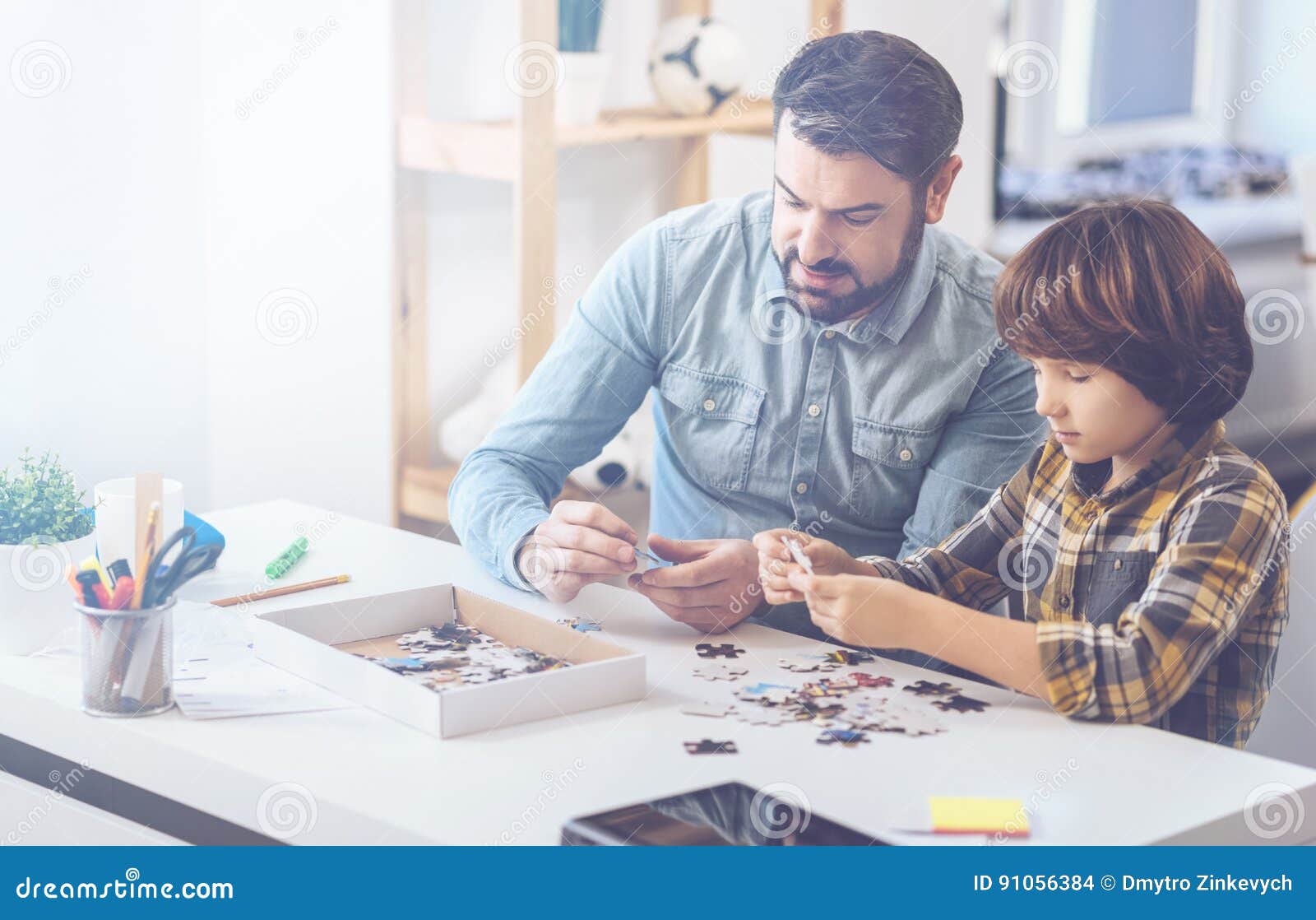 Father and Son Sorting Jigsaw Puzzle on Table Stock Photo - Image of ...