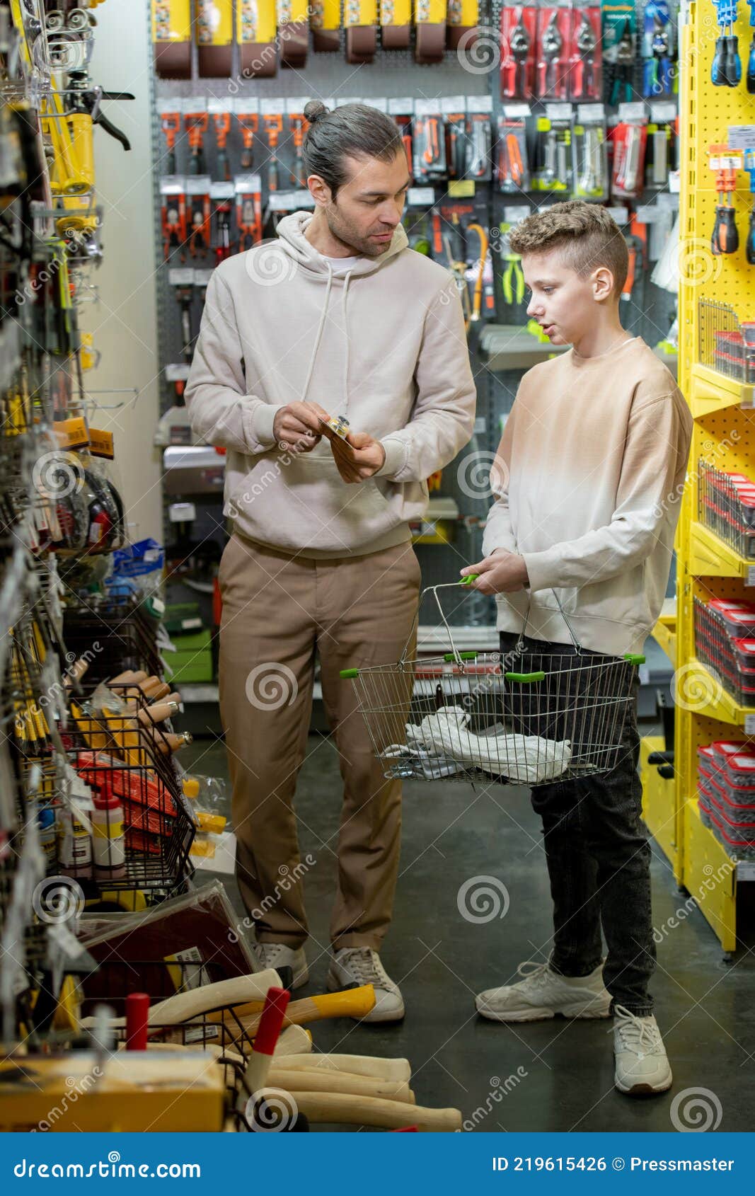Father and Son Standing in One of Departments of Hardware Store Stock ...