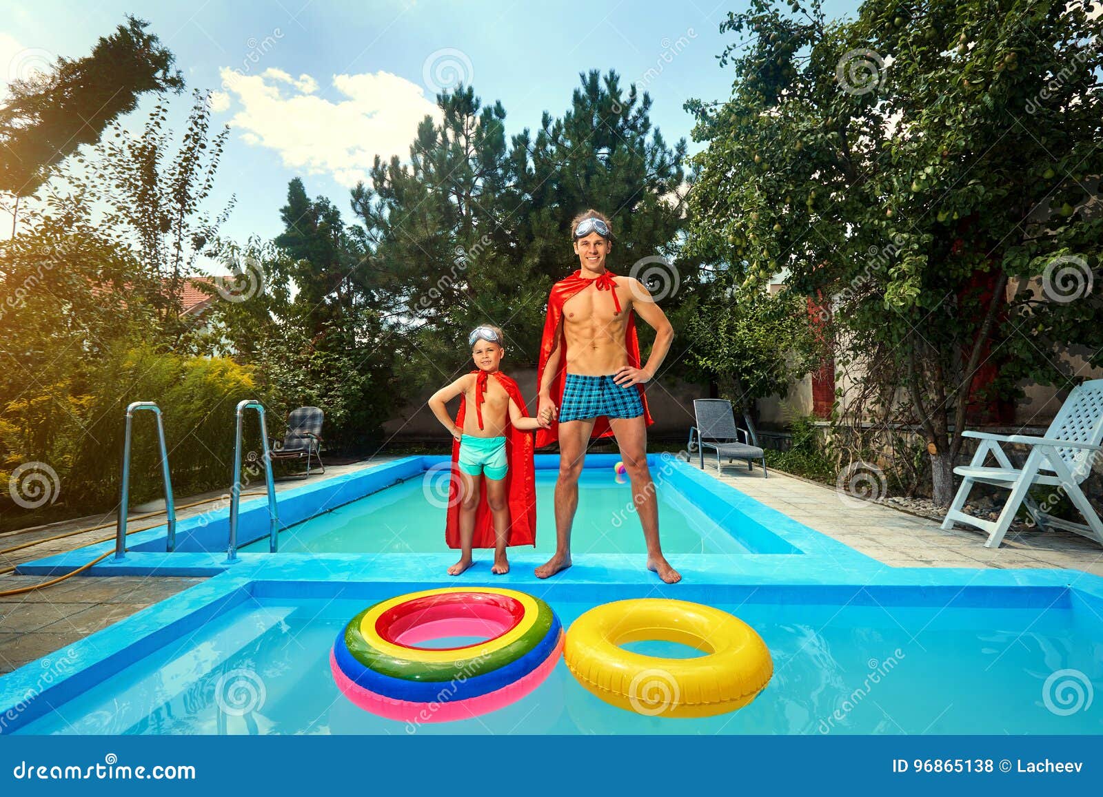 Father and Son in Suits of Superheroes in the Pool in the Summer Stock ...
