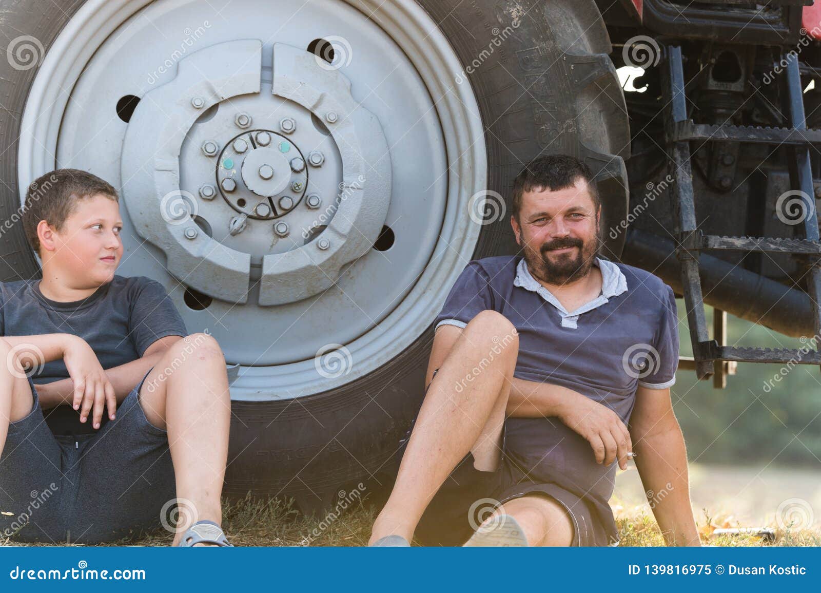 Father and Son Taking a Break after Hard Work at Field Stock Image ...