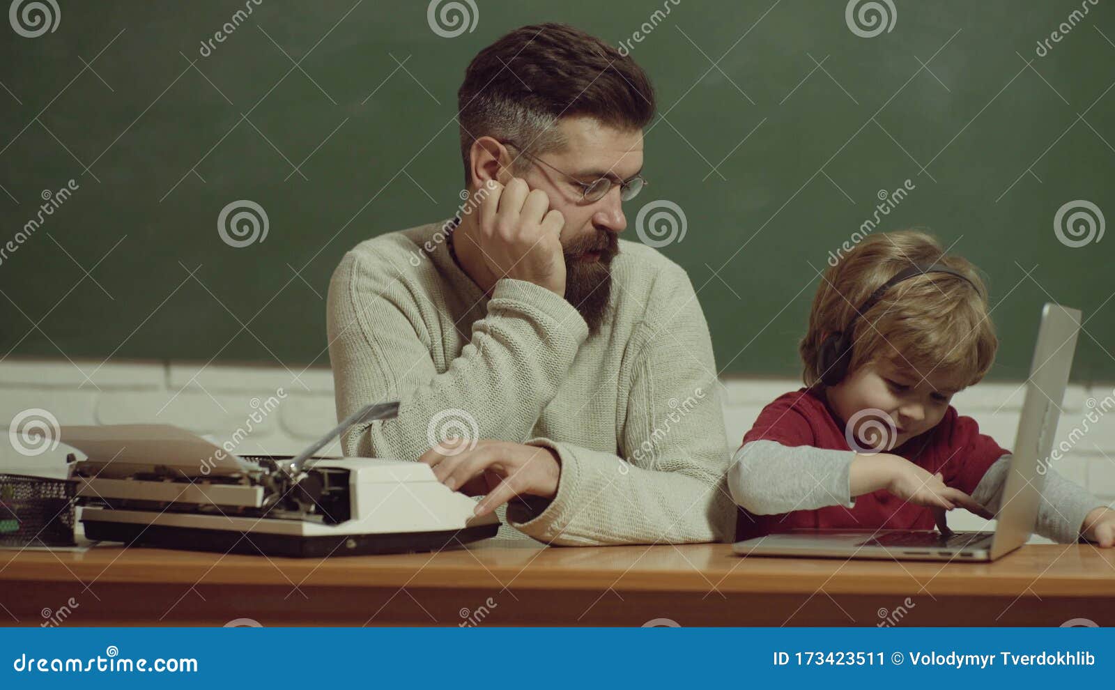Father and Son Typing on Old Typewriter and Laptop. Old and Young ...