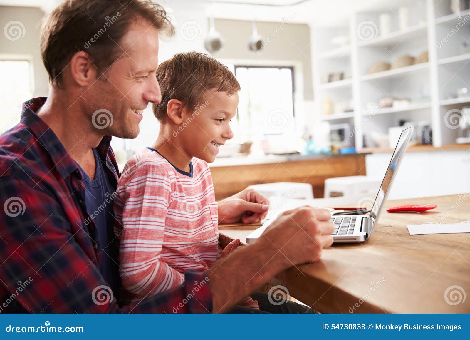 Father and Son Using Laptop Computer at Home Stock Photo - Image of ...