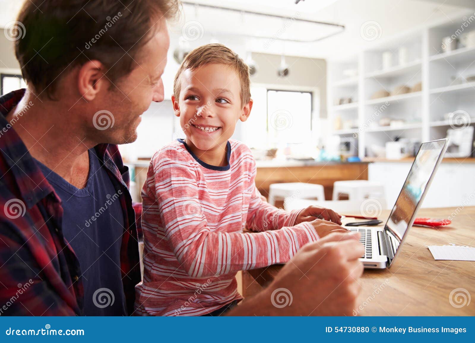 Father and Son Using Laptop Computer at Home Stock Photo - Image of ...