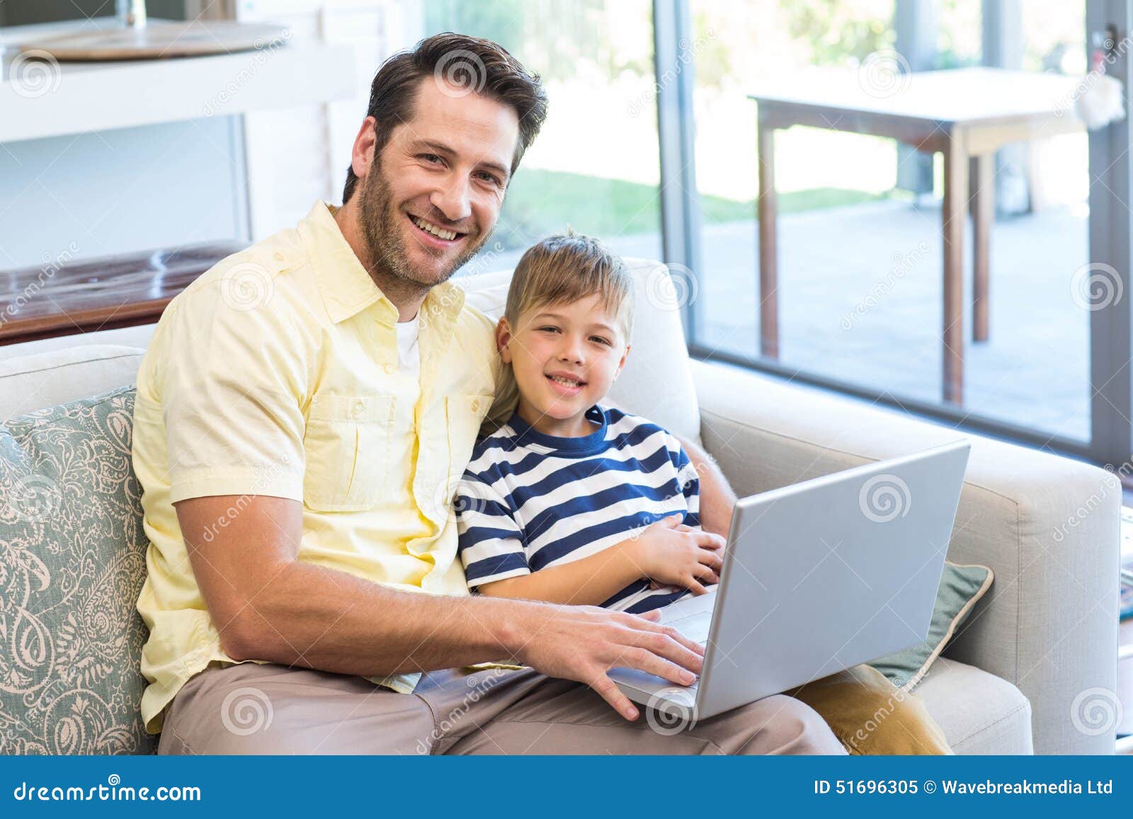 Father and Son Using Laptop on the Couch Stock Image - Image of ...