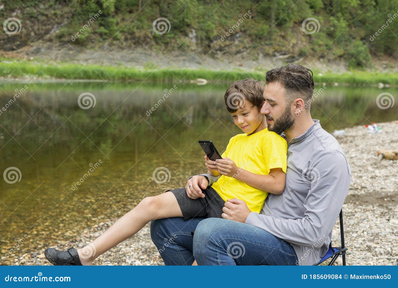 Father and Son Using Smartphone. Concept of Family Moment Using Mobile ...