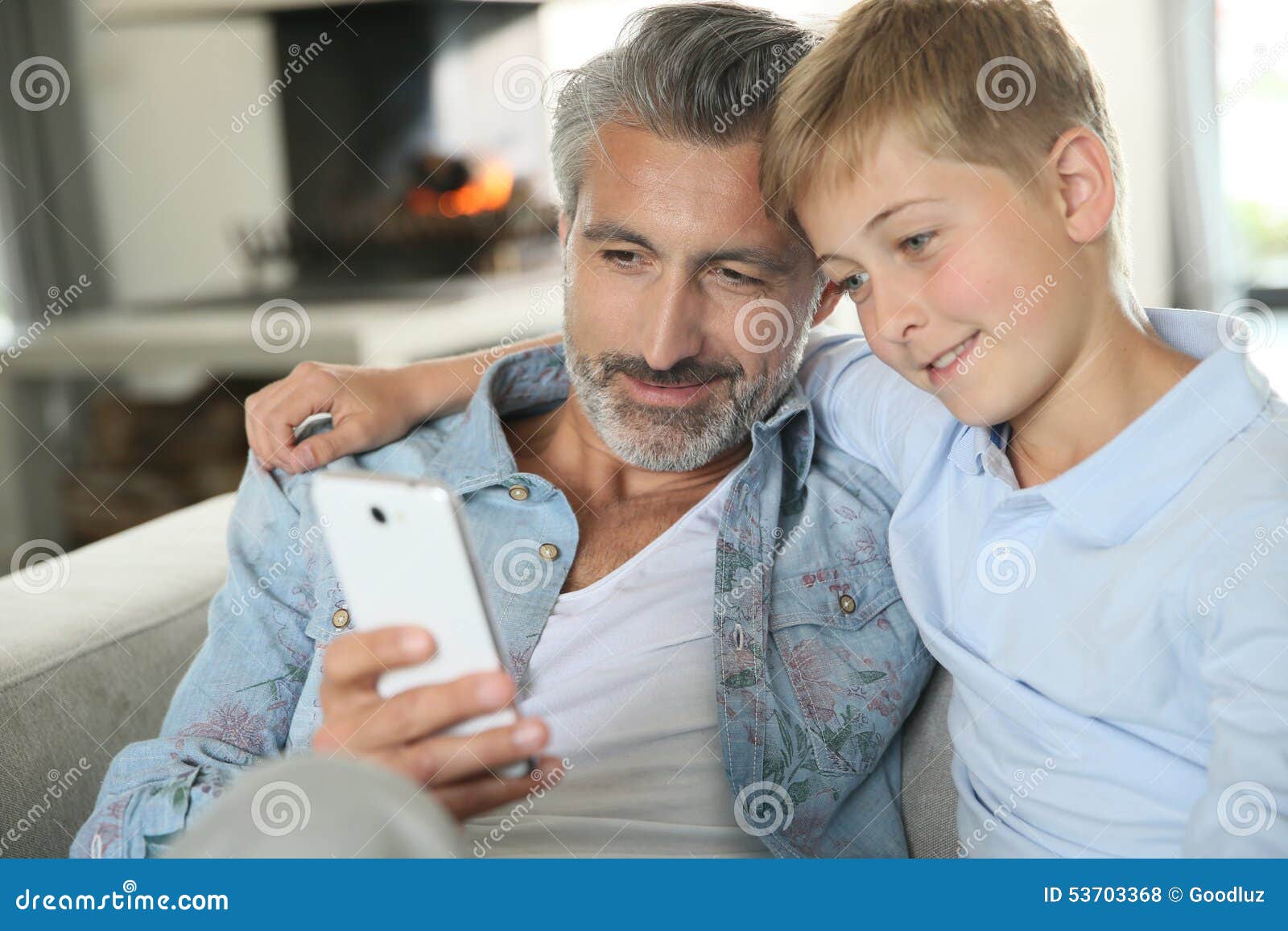 Father and Son Using Smartphone Together Stock Photo - Image of smile ...