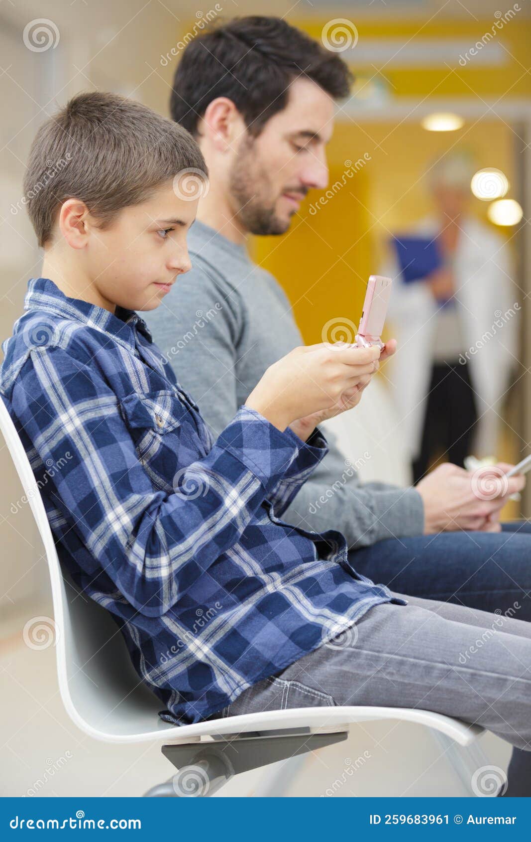 Father and Son in Waiting Room Together Stock Image - Image of father ...
