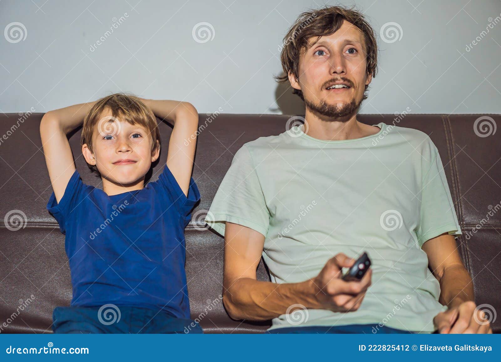 Father and Son Watching TV in Evening at Home Stock Photo - Image of ...