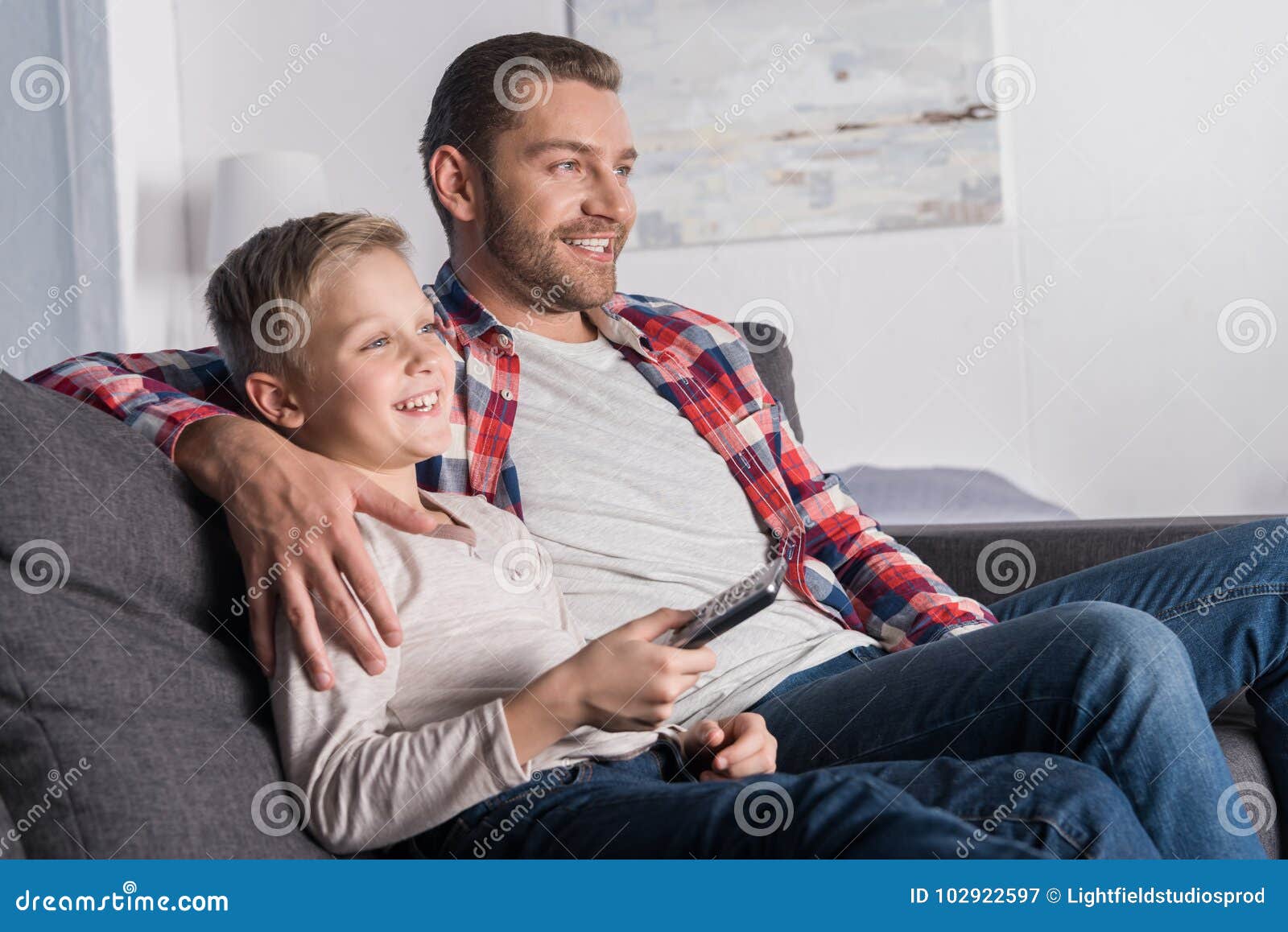 Father and son watching tv stock image. Image of people - 102922597