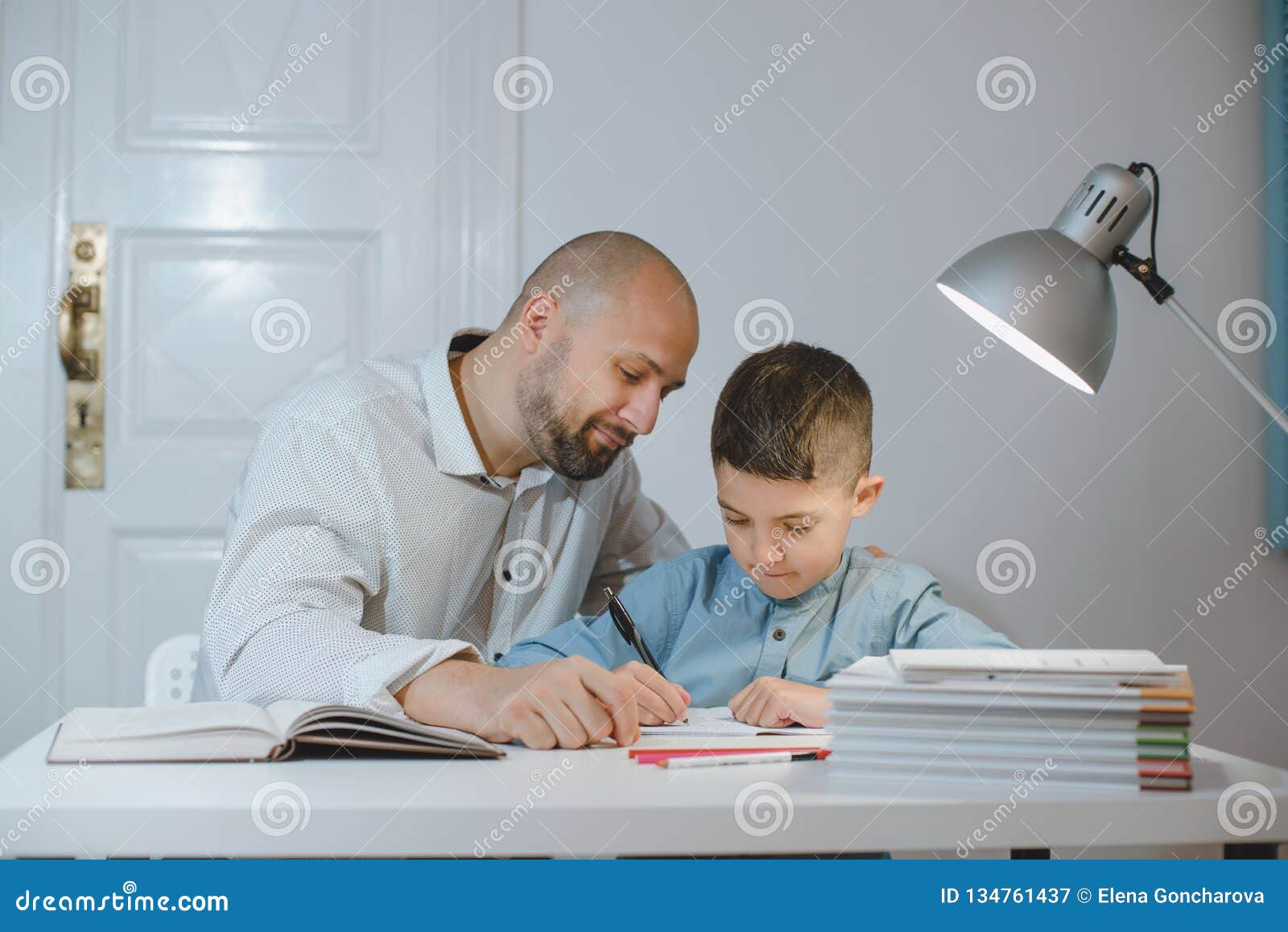 Father and Son Work Together on School Homework or Homeschooling. Stock ...