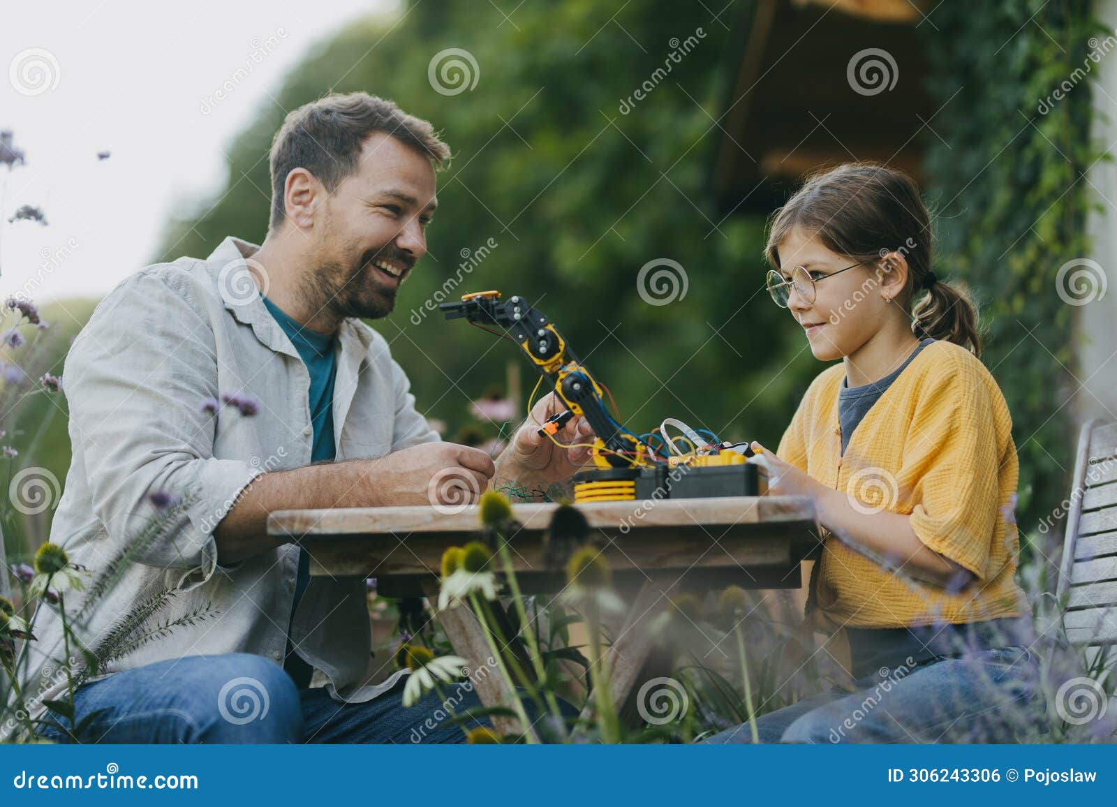 Father And Son Programming Robot While Kids Dance And Play At Home ...