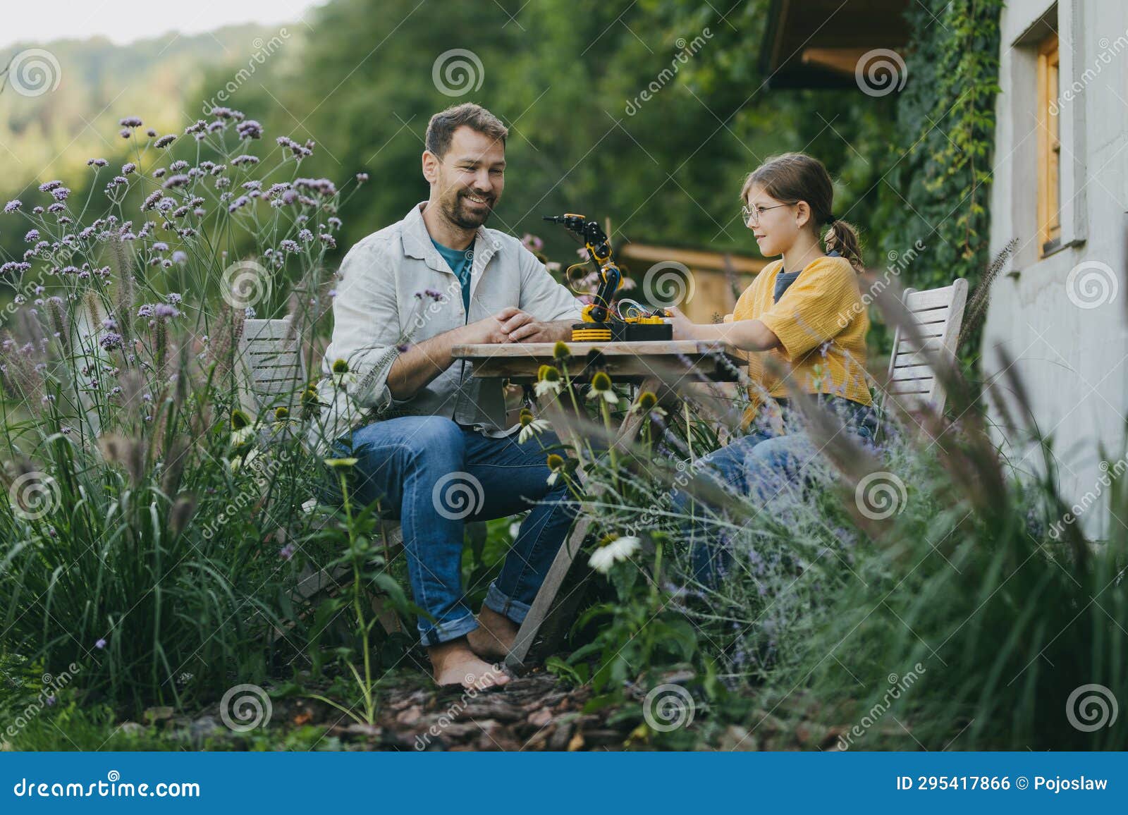 Father And Son Programming Robot While Kids Dance And Play At Home ...