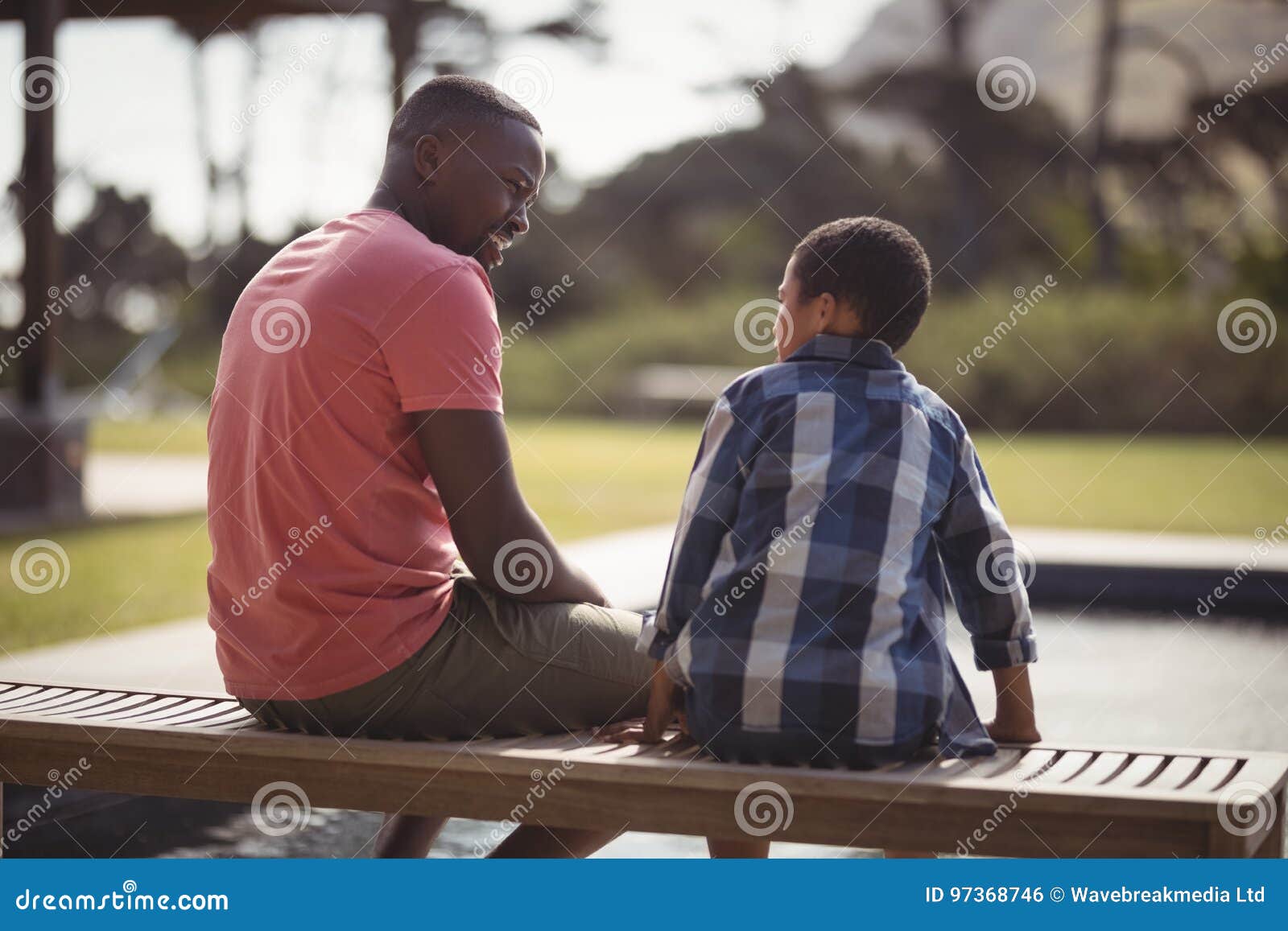 Father Talking To Son Near Pool Side Stock Photo - Image of adult ...