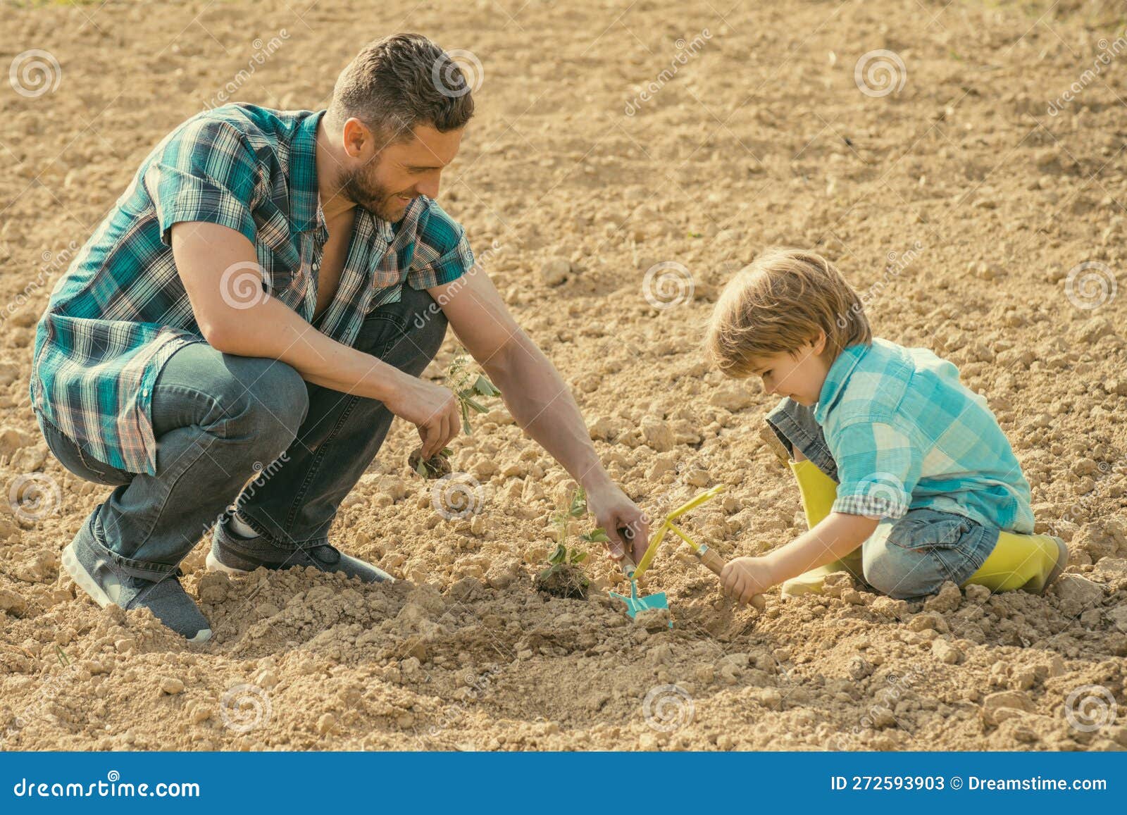 Father Teaching His Son Gardening. Father and Son Work in Garden. Stock ...