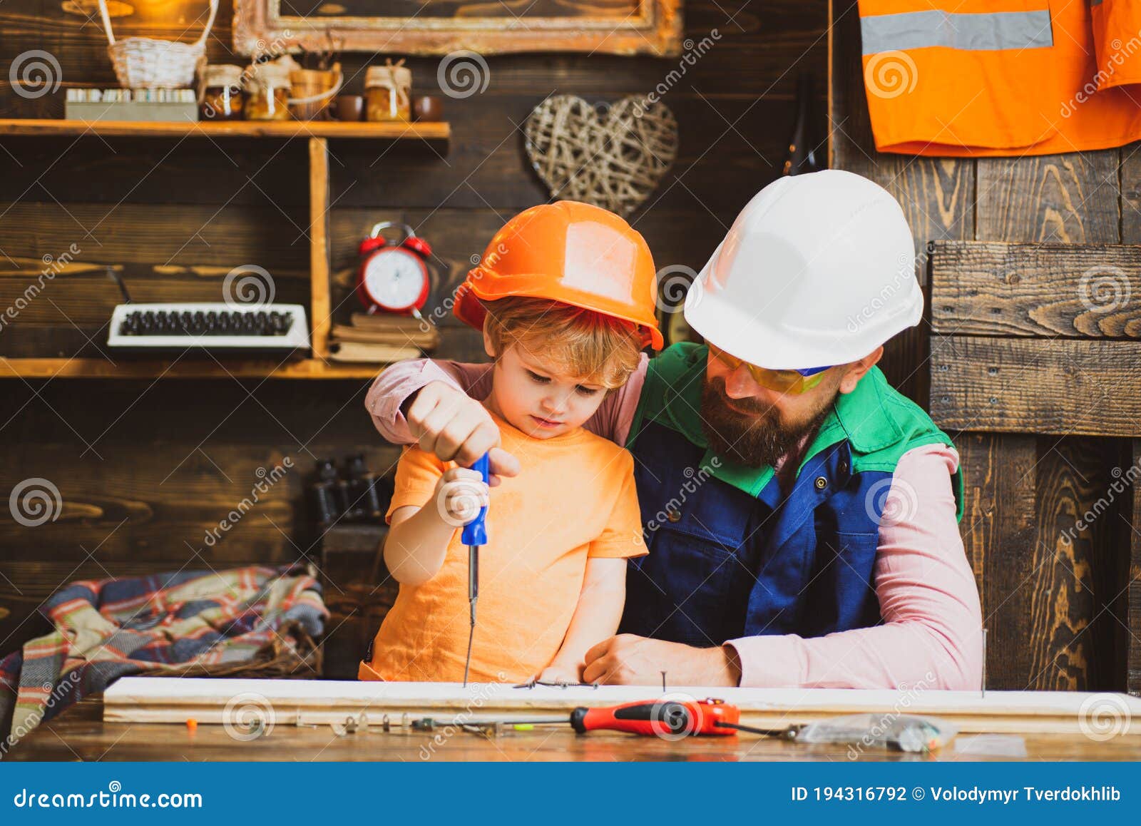 Father is Teaching His Son To Use the Screwdriver and Hammer. Work with ...