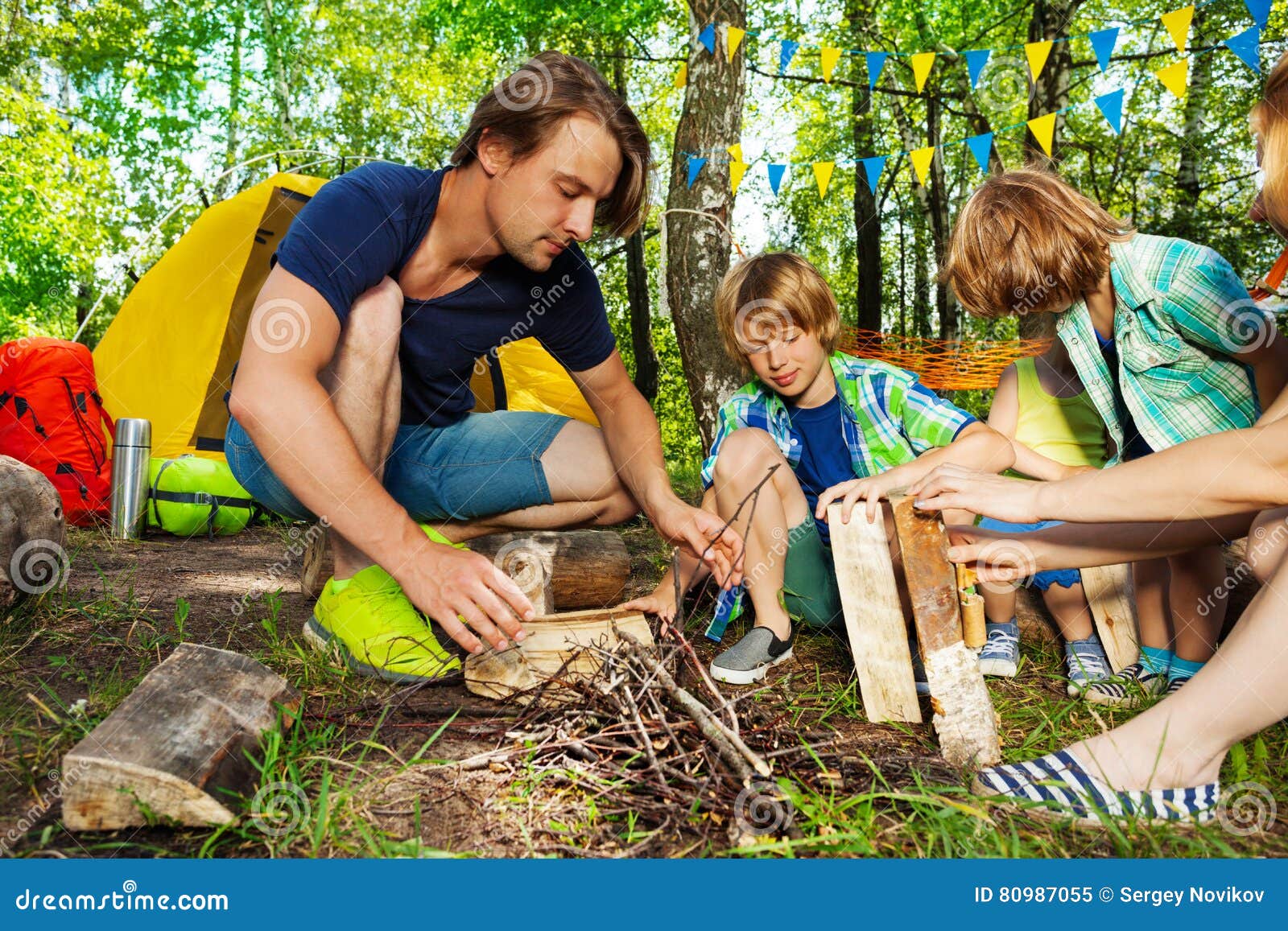 Father Teaching Kids To Make a Camp Fire in Forest Stock Image - Image ...