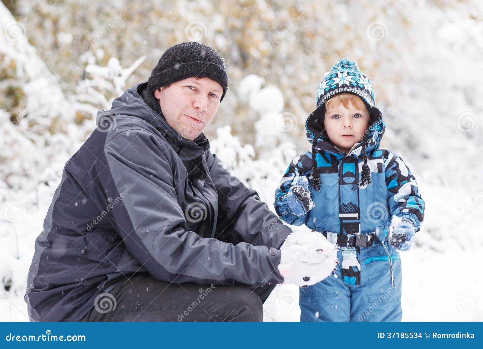 Father and Toddler Boy Having Fun with Snow on Winter Day Stock Photo ...