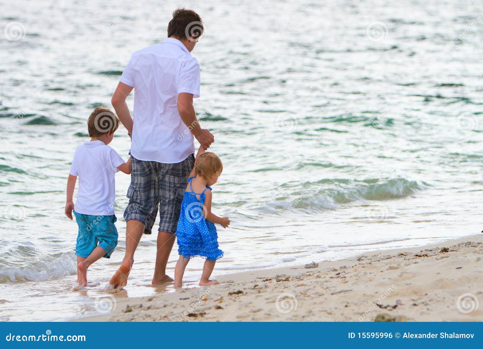 Father with Two Kids Walking Along Beach Stock Photo - Image of people ...