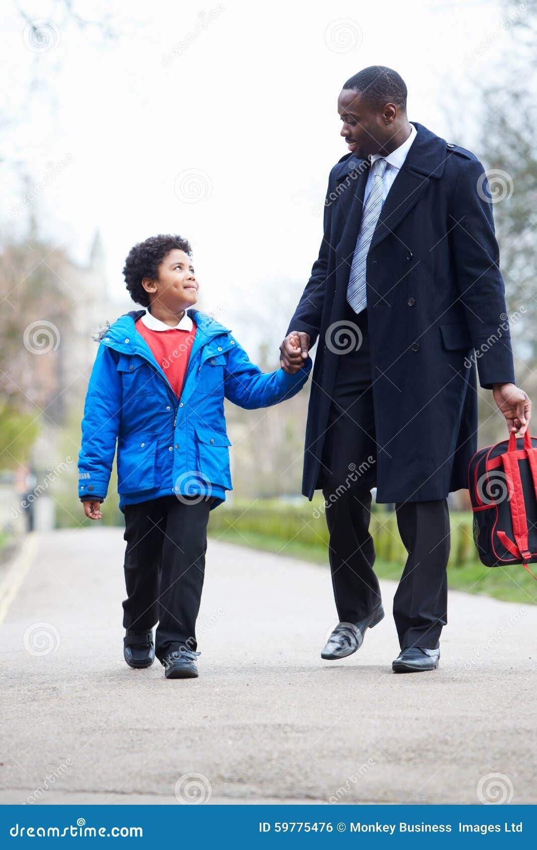 Father Walking Son To School Along Path Stock Photo - Image of hands ...