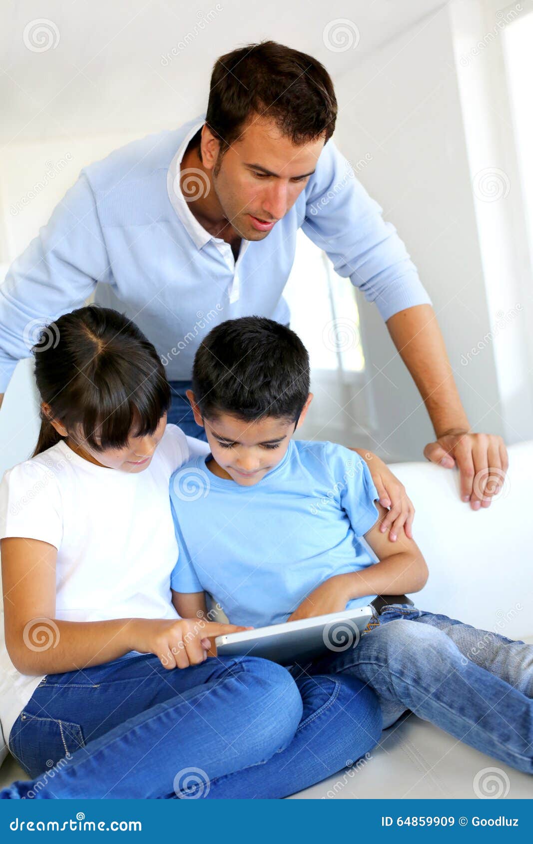 Father Watching Over Children Using Tablet Stock Image - Image of ...