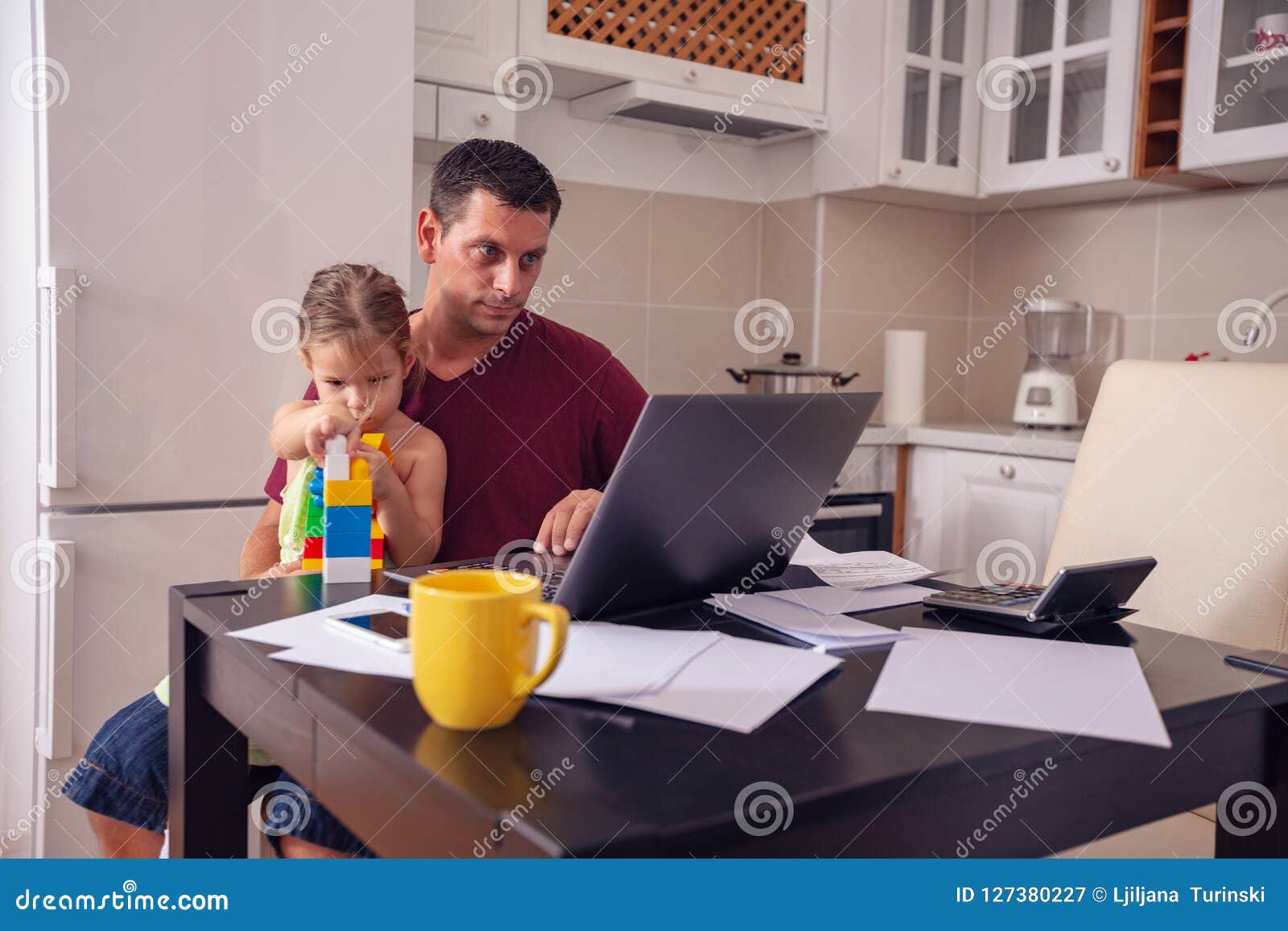 Father Working with Computer while Looking after His Daughter. Stock ...