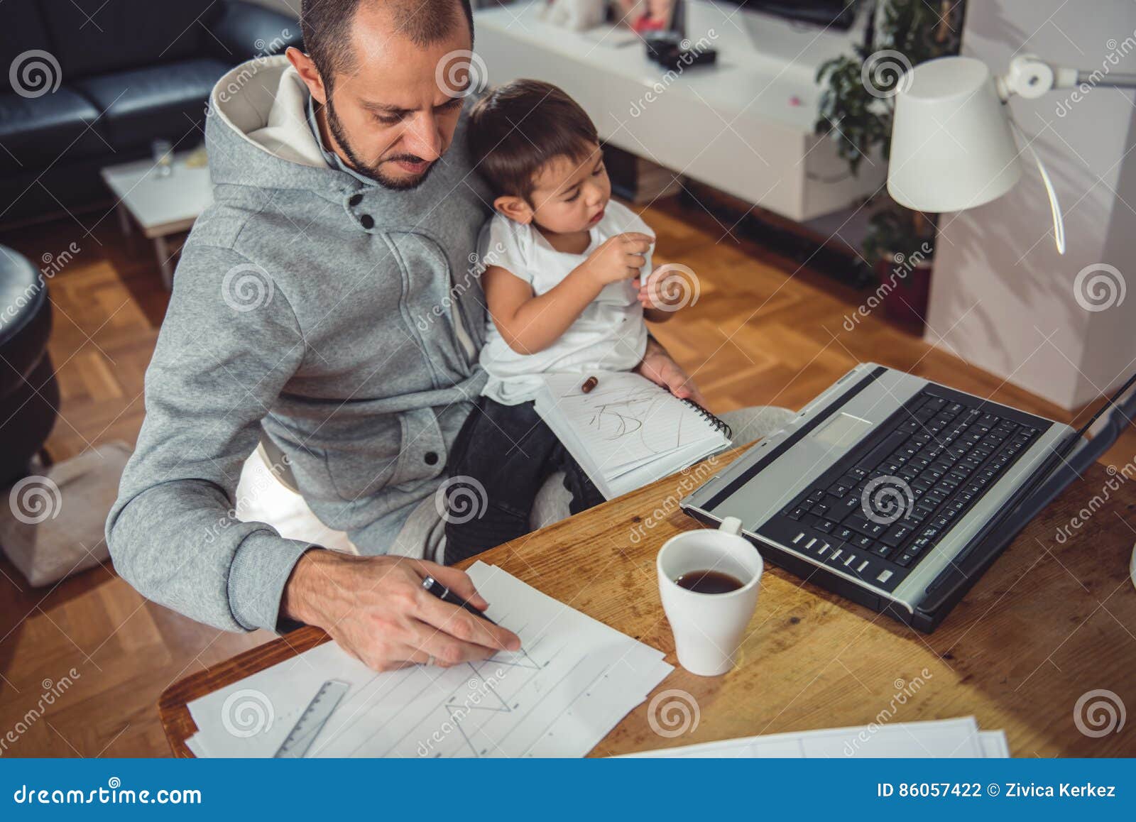 Father Working at Home and Holding Son on His Lap Stock Photo - Image ...