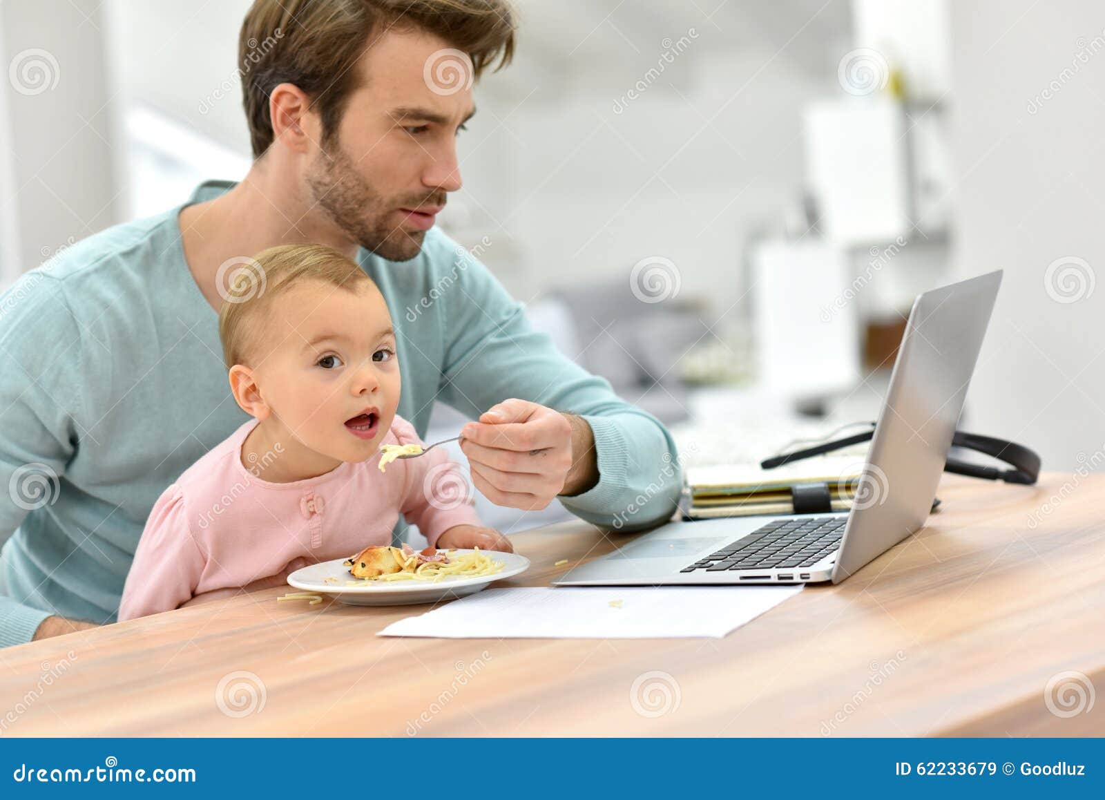 Father Working on Laptop and Feeding Baby Stock Image - Image of ...