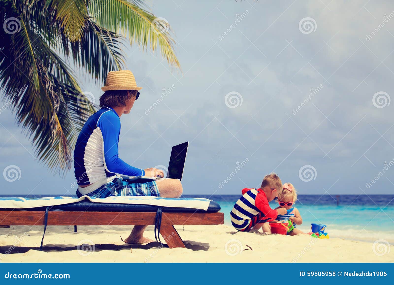 Father Working on Laptop while Kids Play at Beach Stock Photo - Image ...
