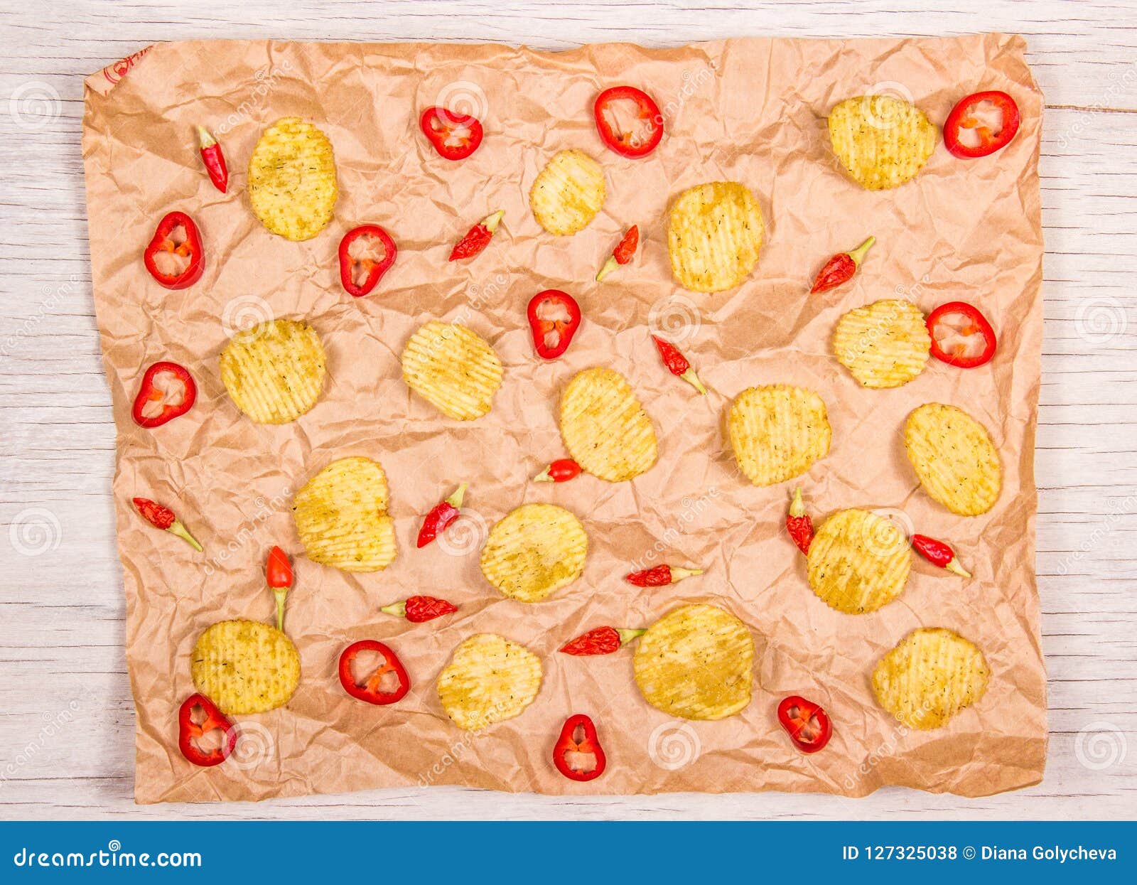 Fatty Potato Chips on Paper. Corrugated Chips with Red Pepper Stock ...