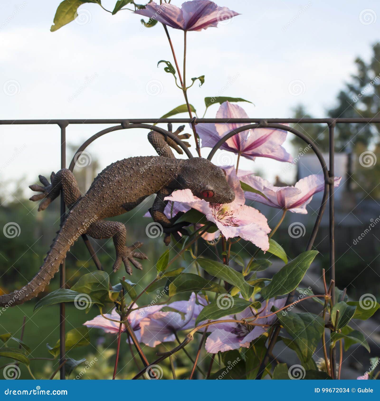 Faux Lizard Sitting on the Arch with Flowers Stock Photo - Image of ...