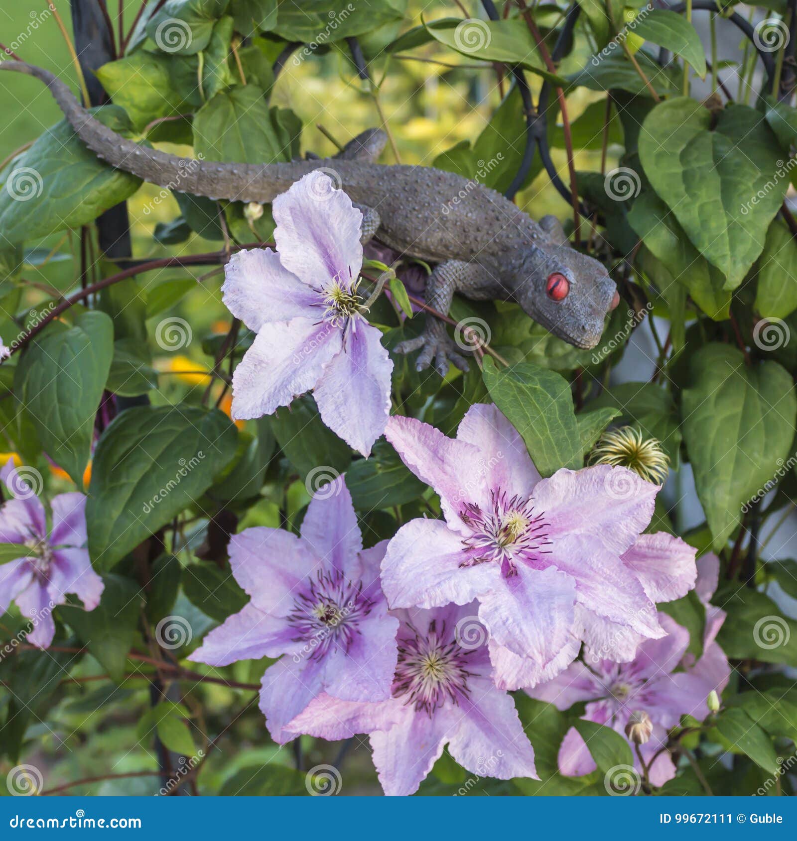 Faux Lizard Sitting on the Arch with Flowers Stock Image - Image of ...