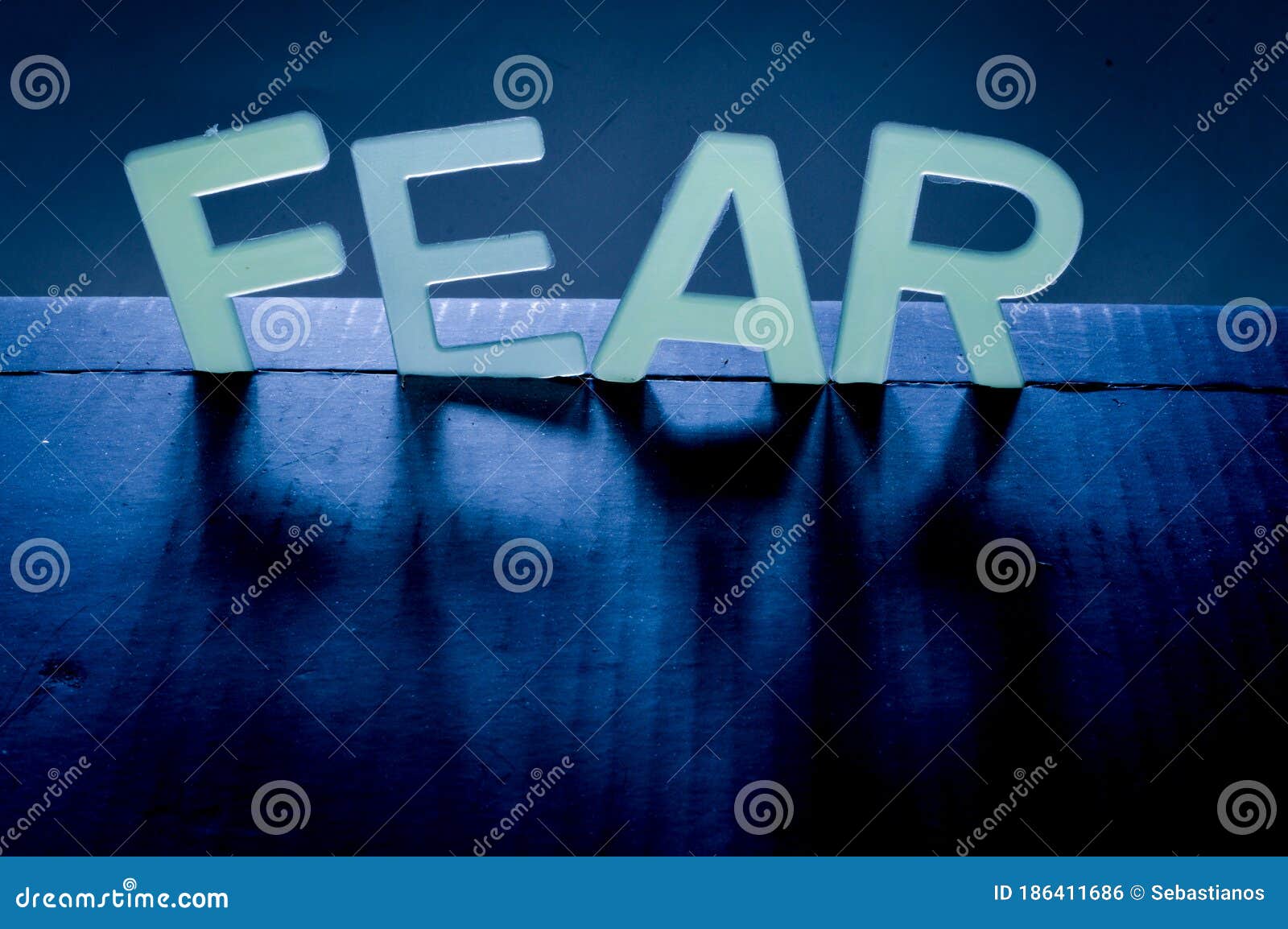 Fear. Word Made by Back Lit Letters on Dark Blue Background with ...