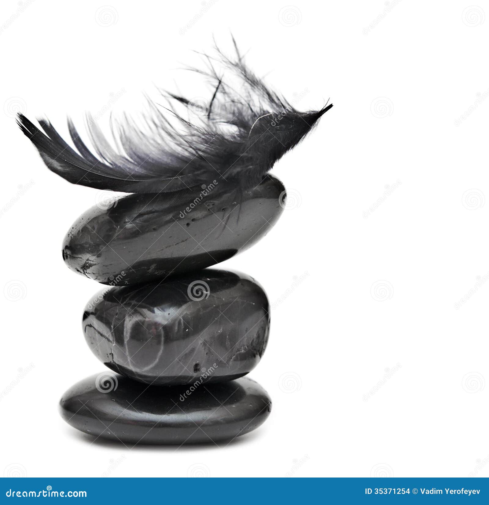 Feather Balancing on Stack of Black Stones Stock Photo - Image of ...