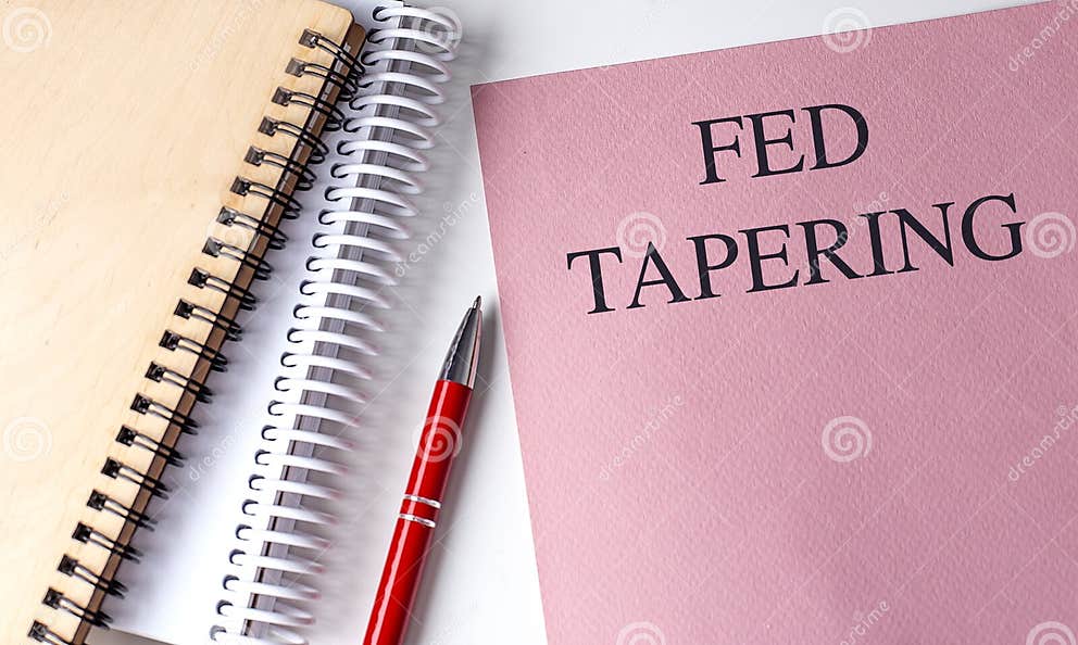 FED TAPERING Text on Pink Paper with Notebooks Stock Photo - Image of ...