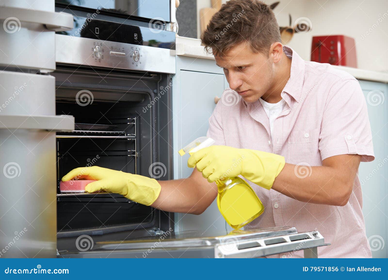 Fed Up Man Cleaning Oven at Home Stock Photo - Image of cleaning, spray ...